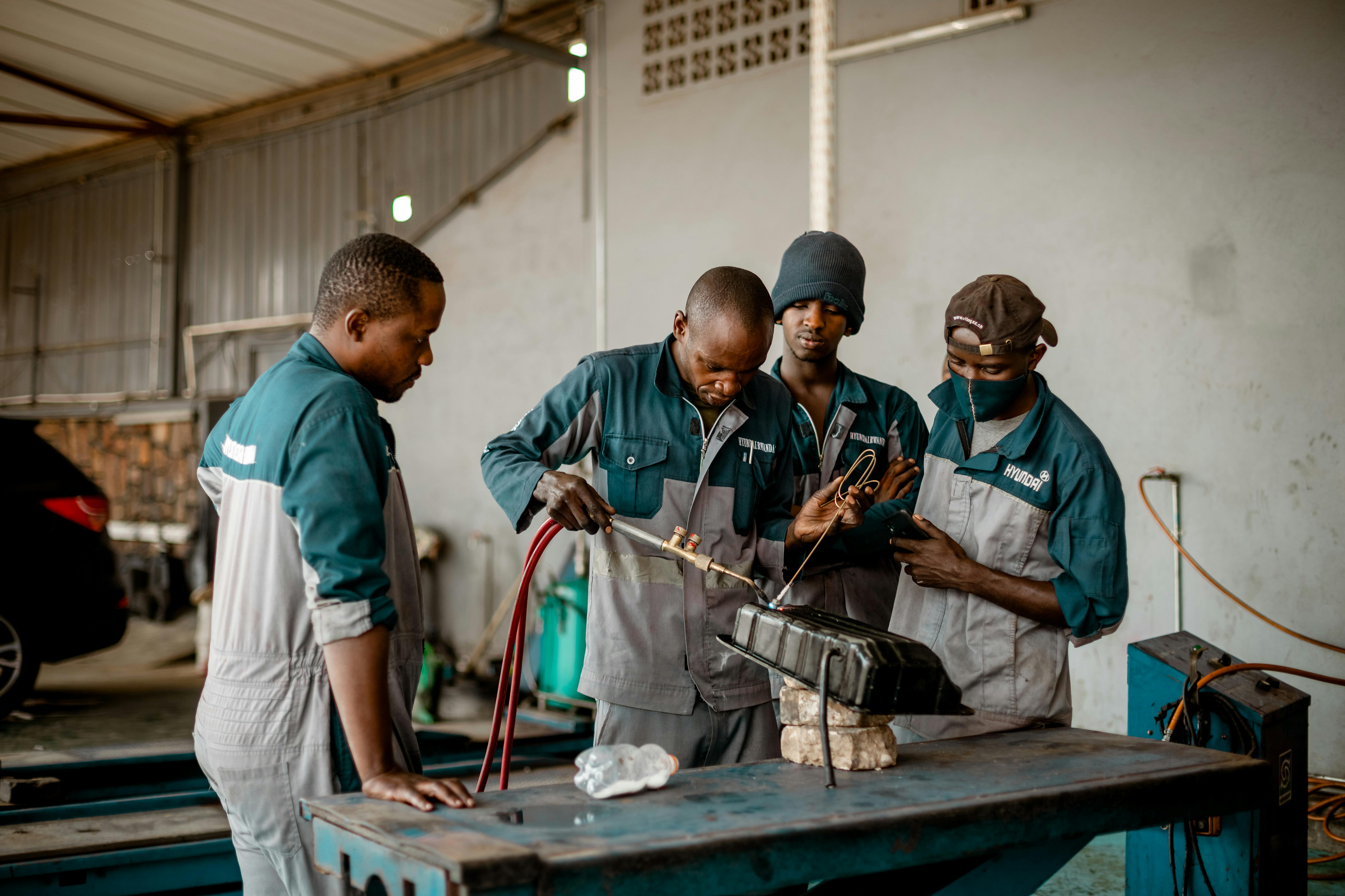 Group of Men doing Metal Work · Free Stock Photo