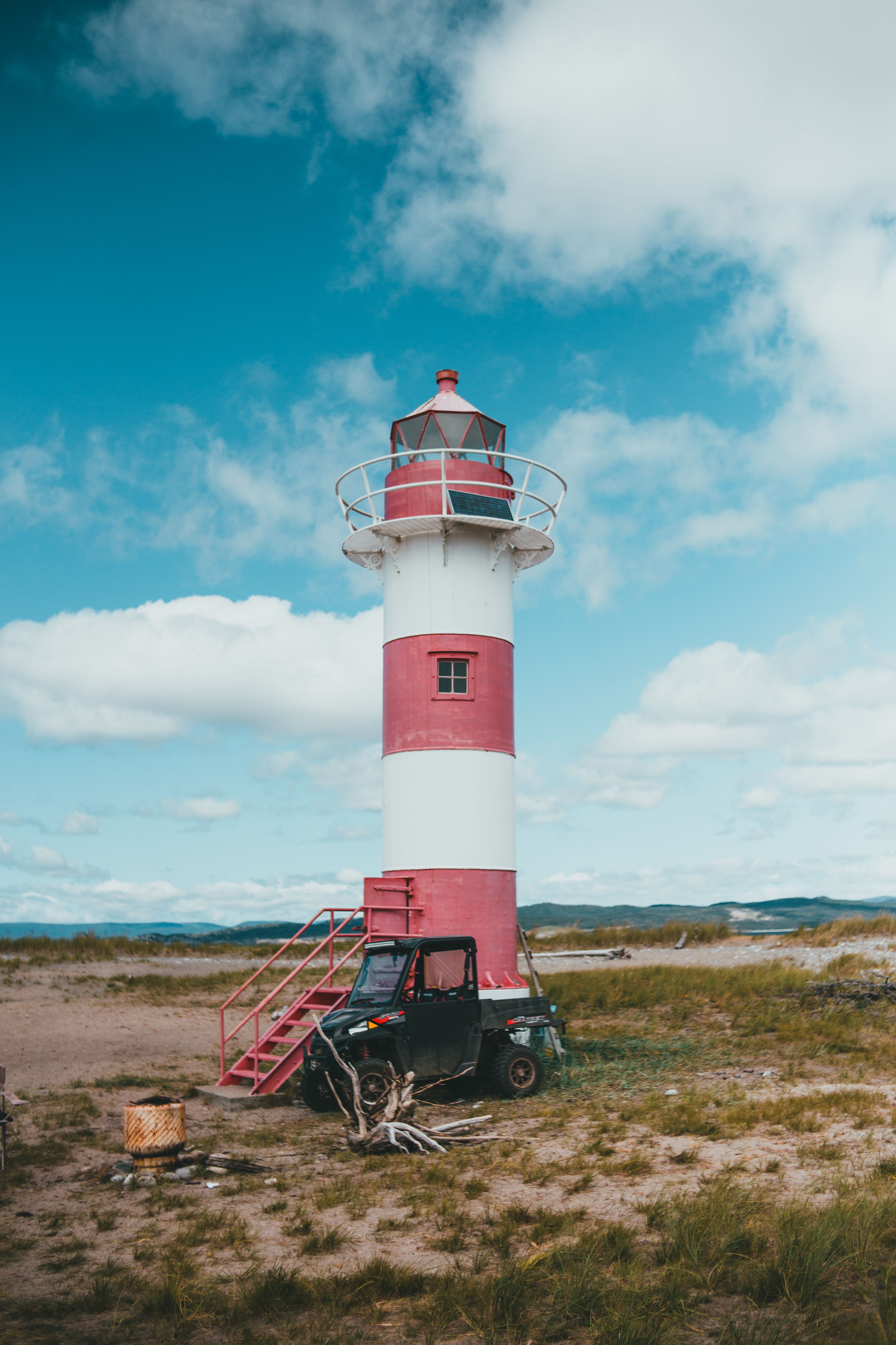 Atv Parked Beside a Lighthouse Tower · Free Stock Photo
