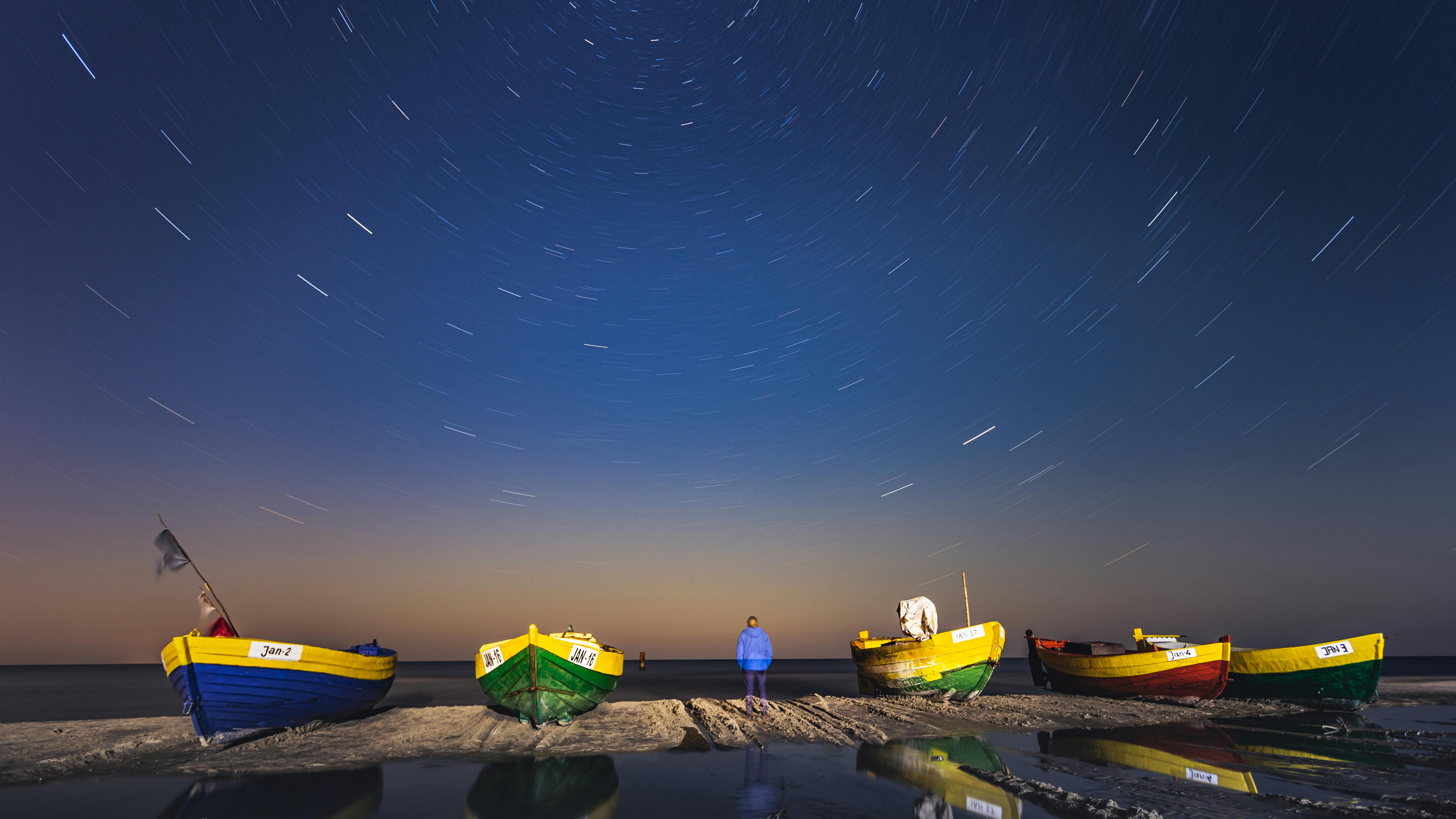 Person Standing in the Middle of Docked Boats on Shore · Free Stock Photo