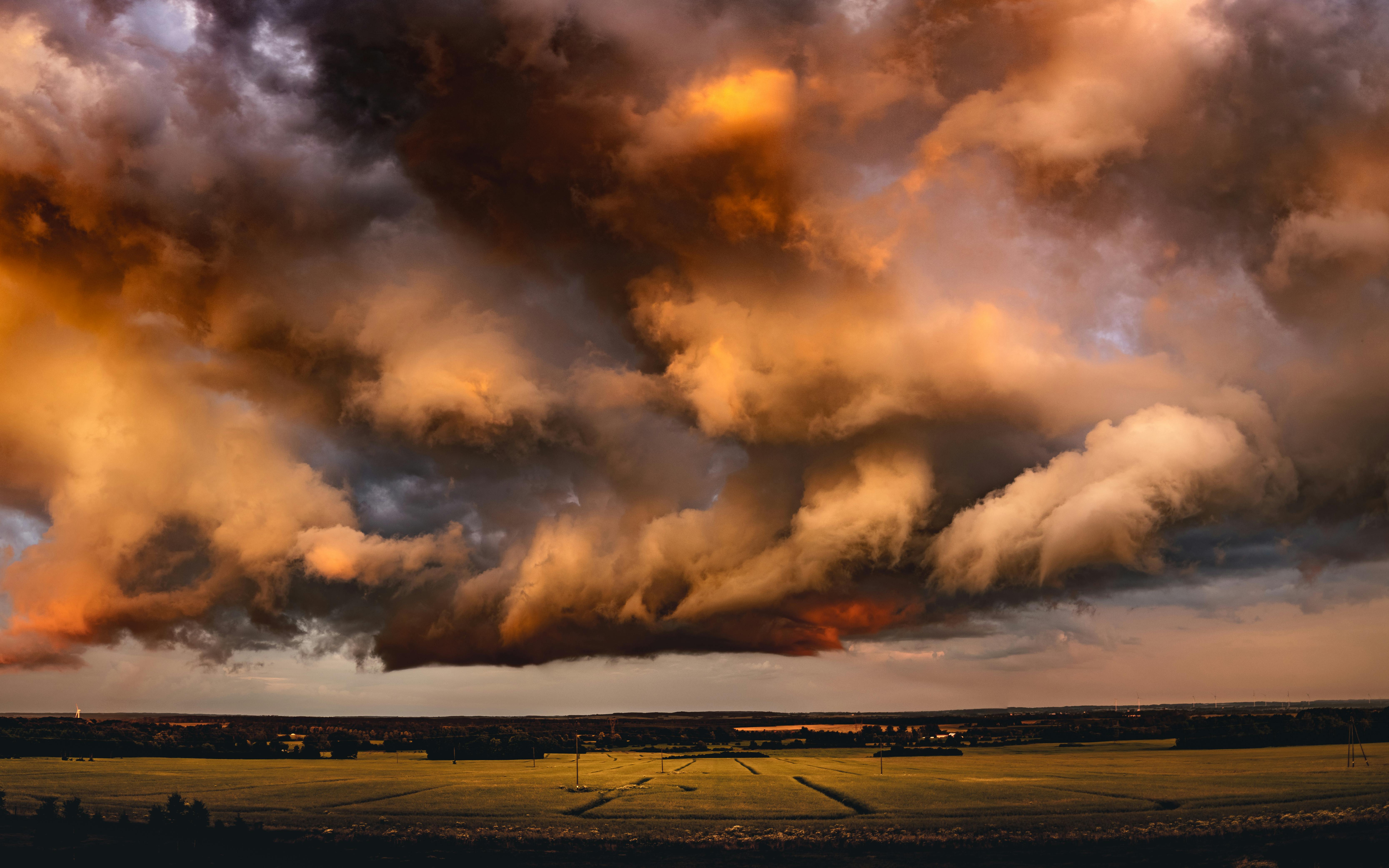 Green Grass Field Under Terrifying Clouds · Free Stock Photo