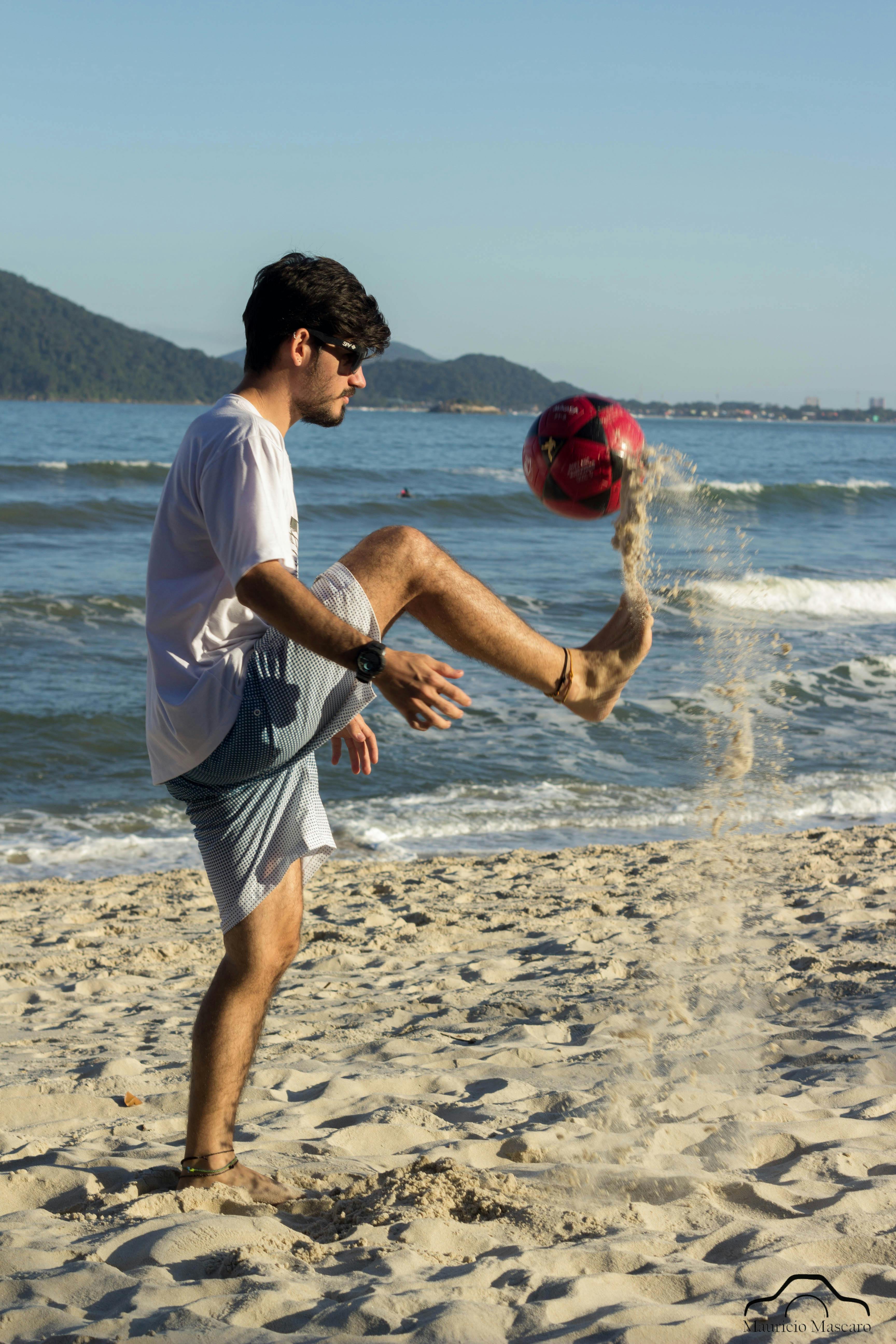 Man Playing with a Soccer Ball at the Beach · Free Stock Photo