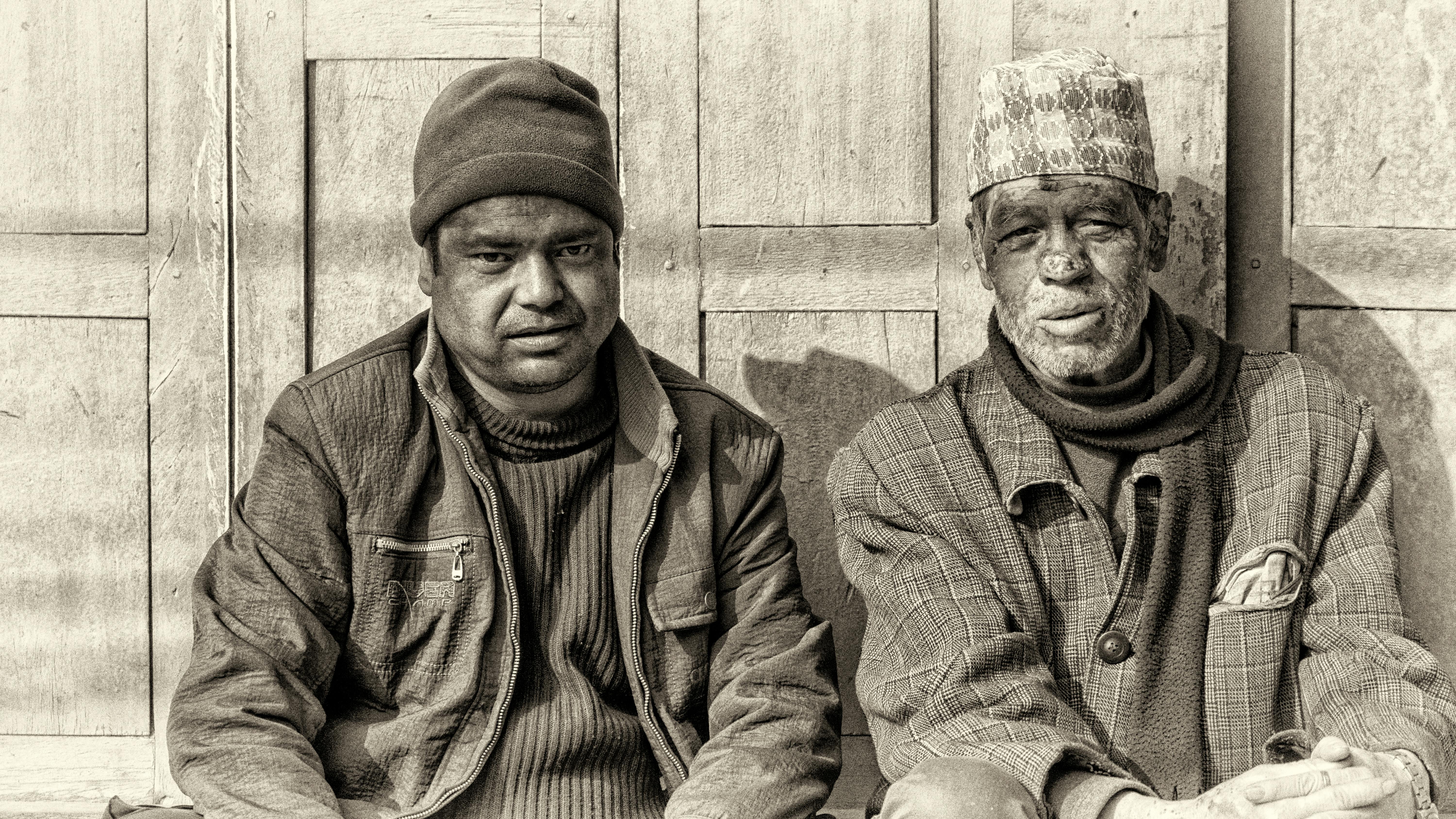 Men sitting beside each other · Free Stock Photo