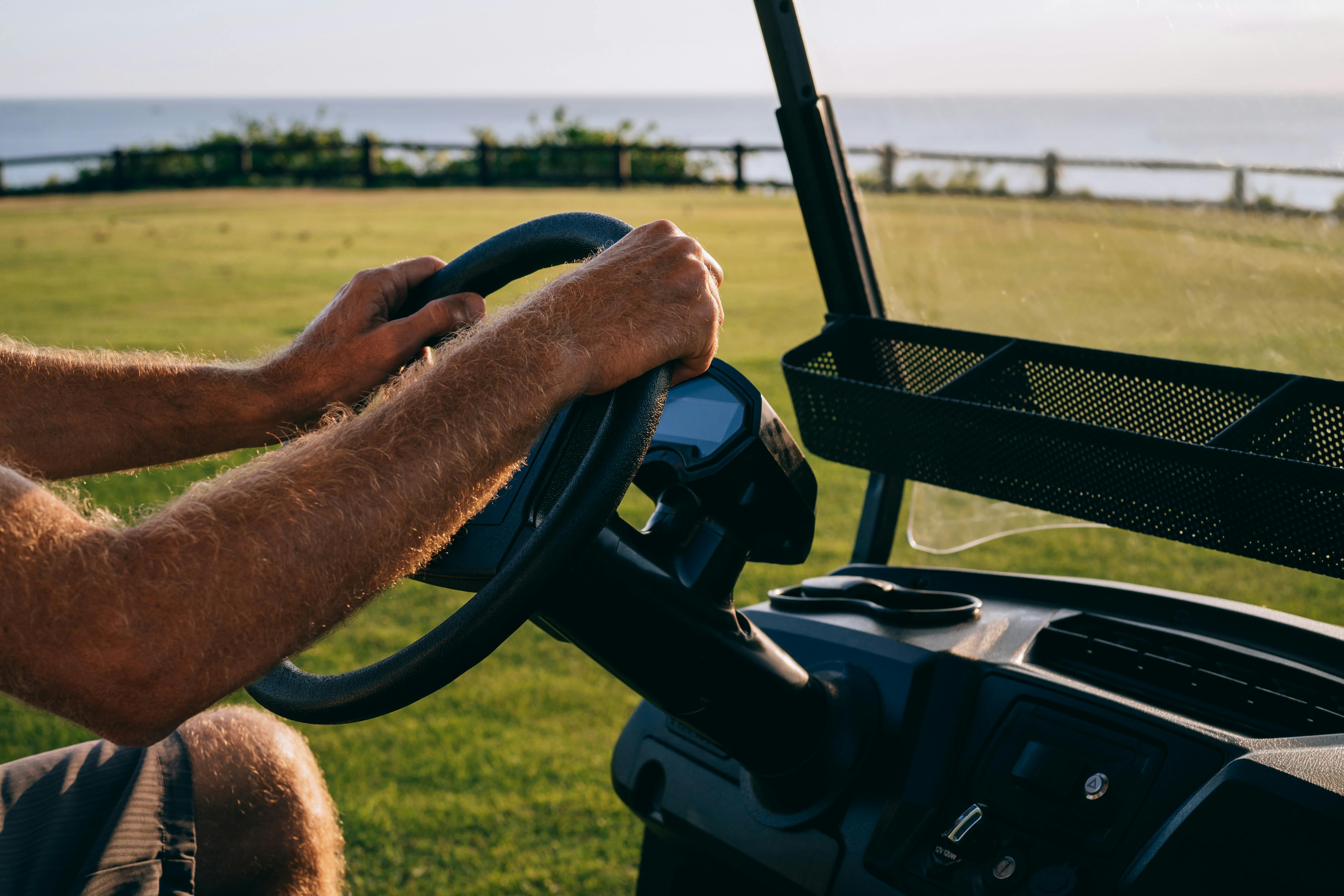 Person Driving a Golf Cart · Free Stock Photo