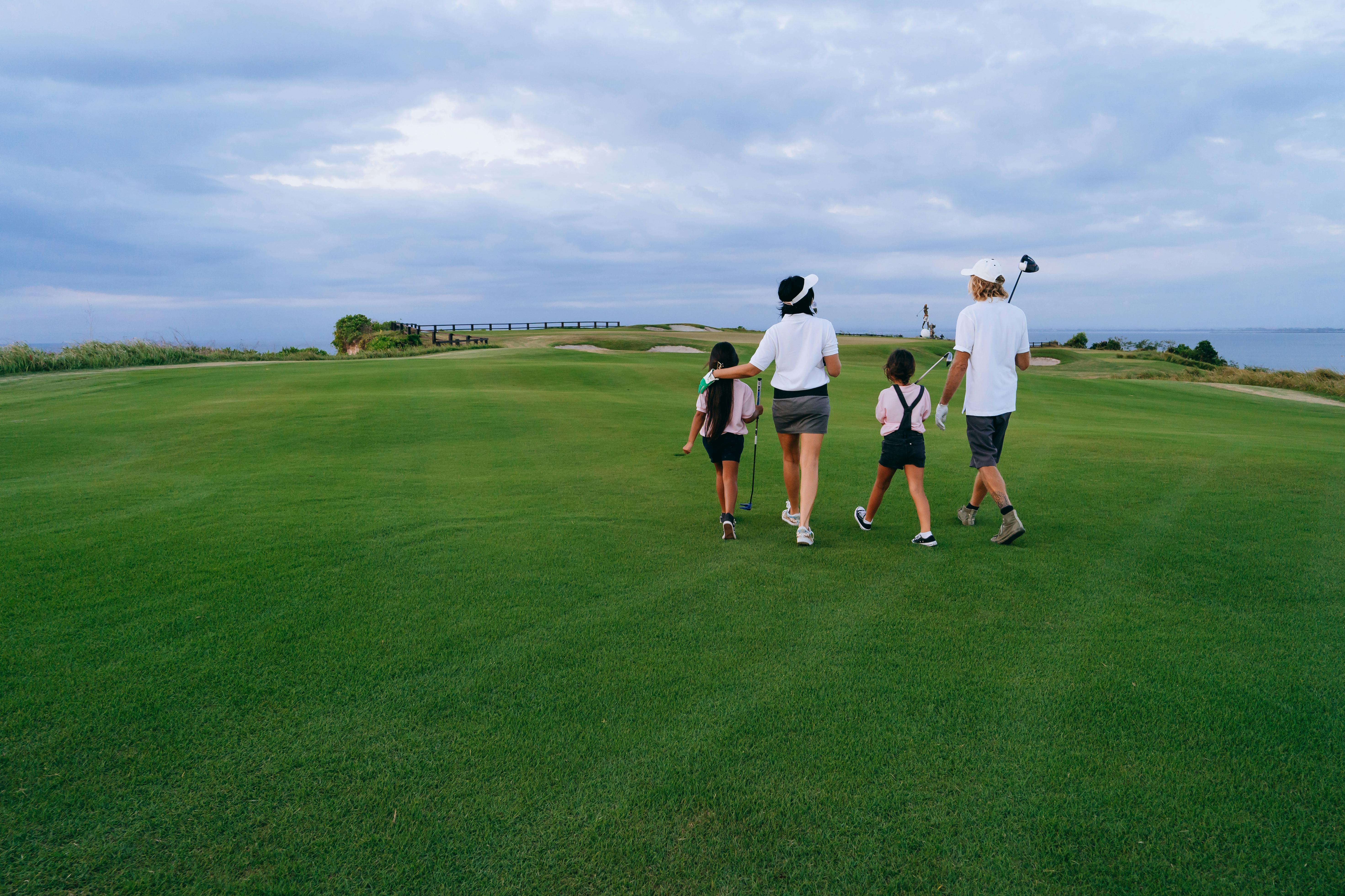 Family Walking on Golf Course · Free Stock Photo