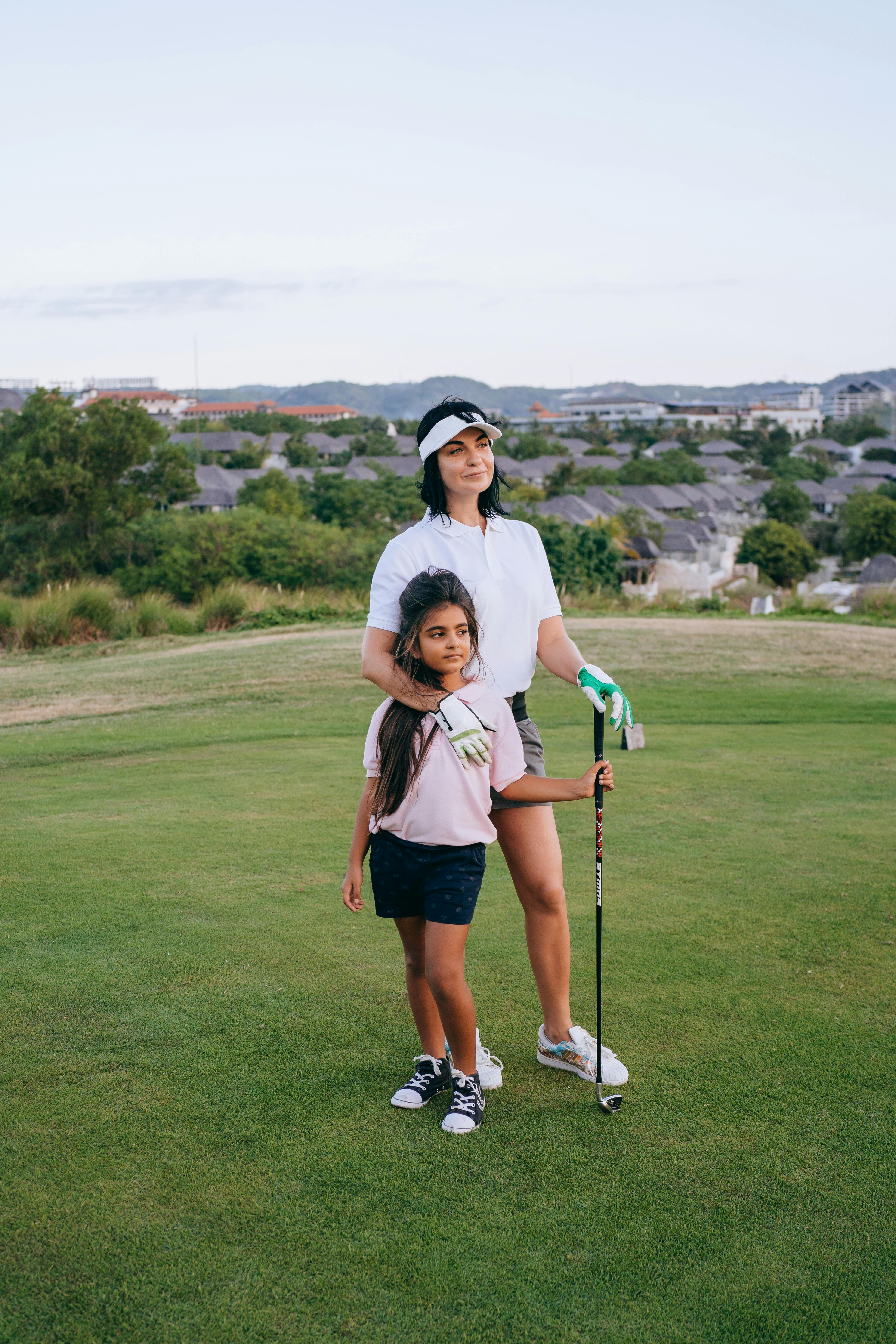 A Mother and Her Daughter on a Golf Course · Free Stock Photo