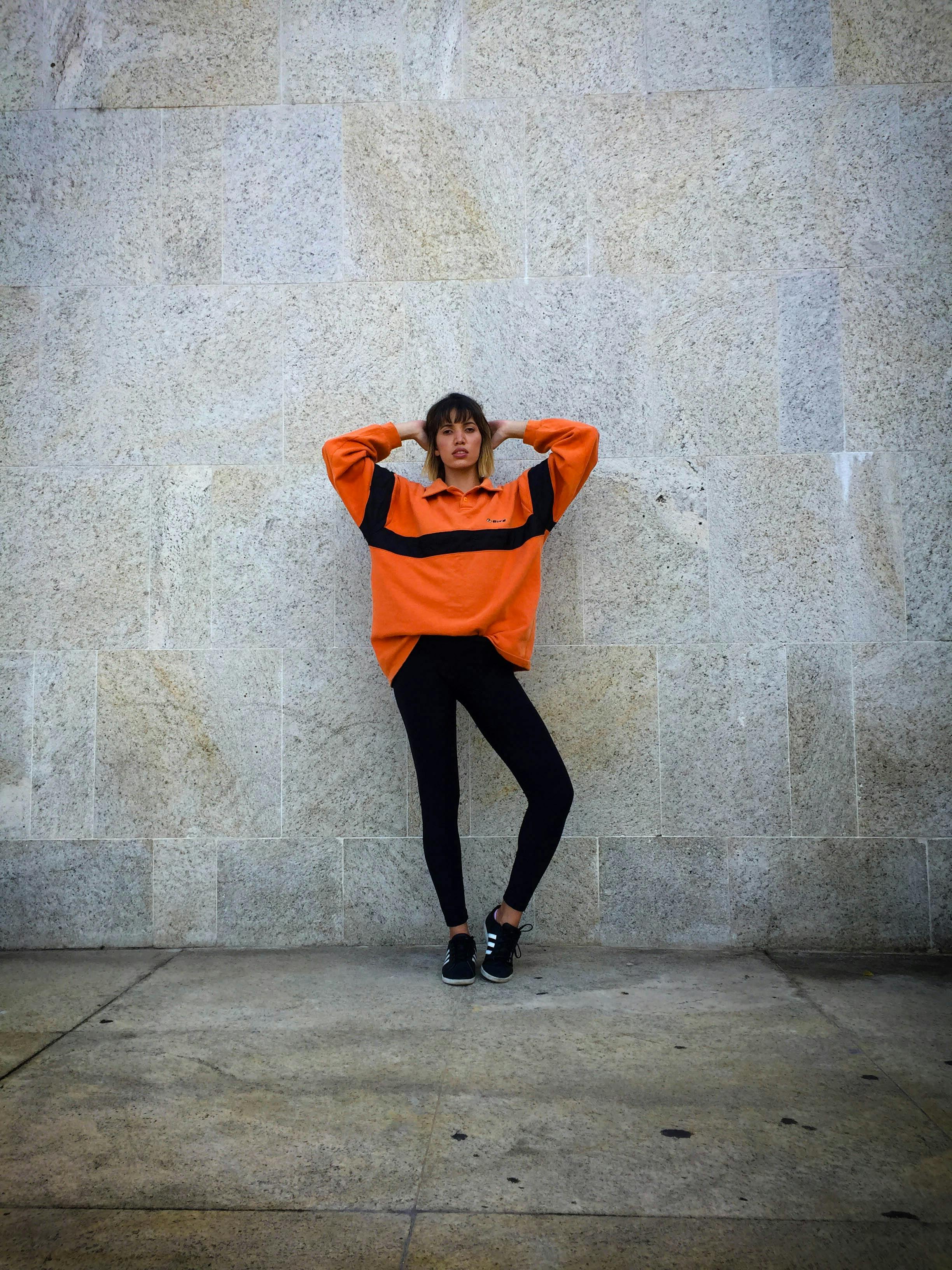 Stylish Woman in Streetwear Posing near Building Wall · Free Stock Photo