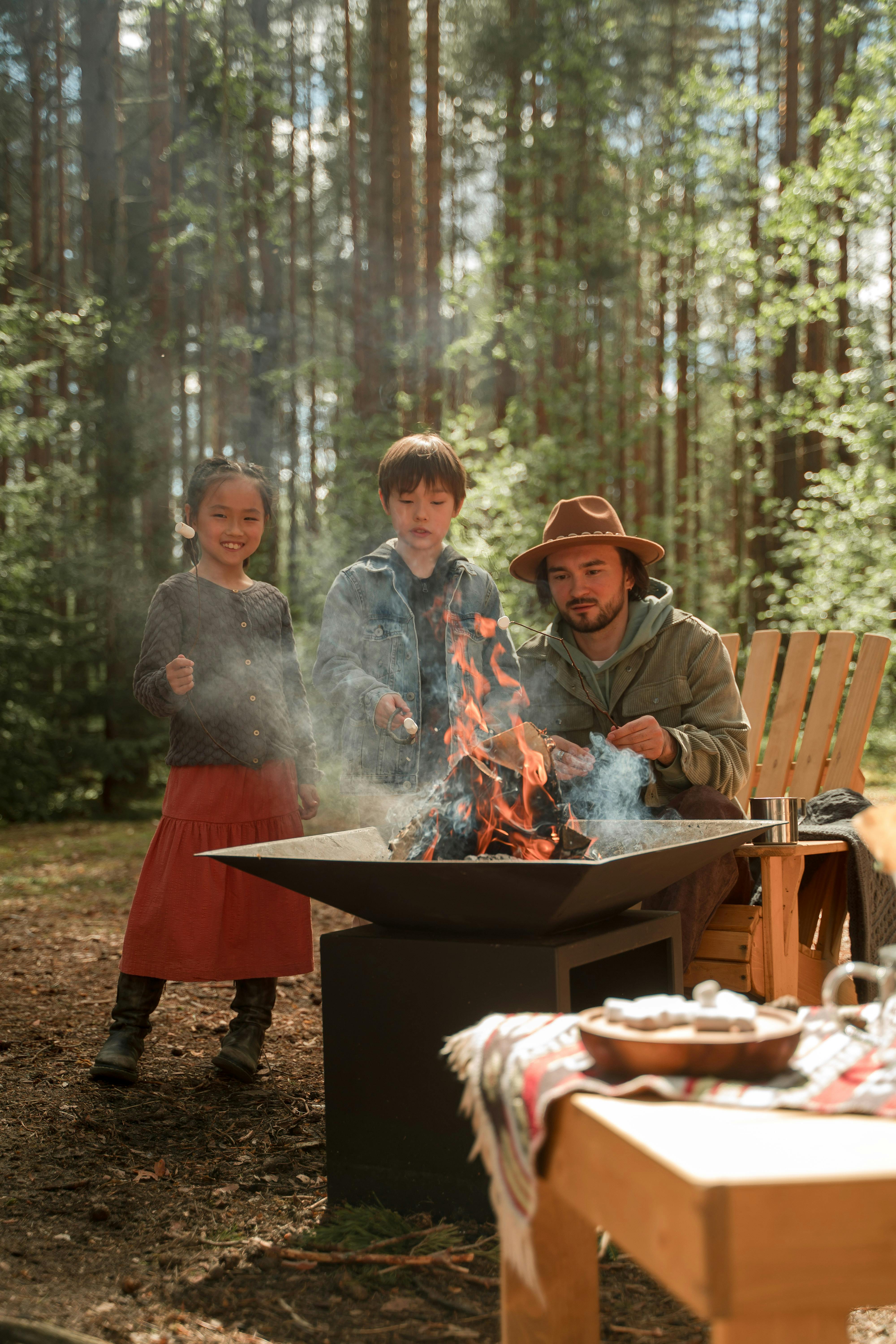 A Man Making Fire in a Fire Pit · Free Stock Photo