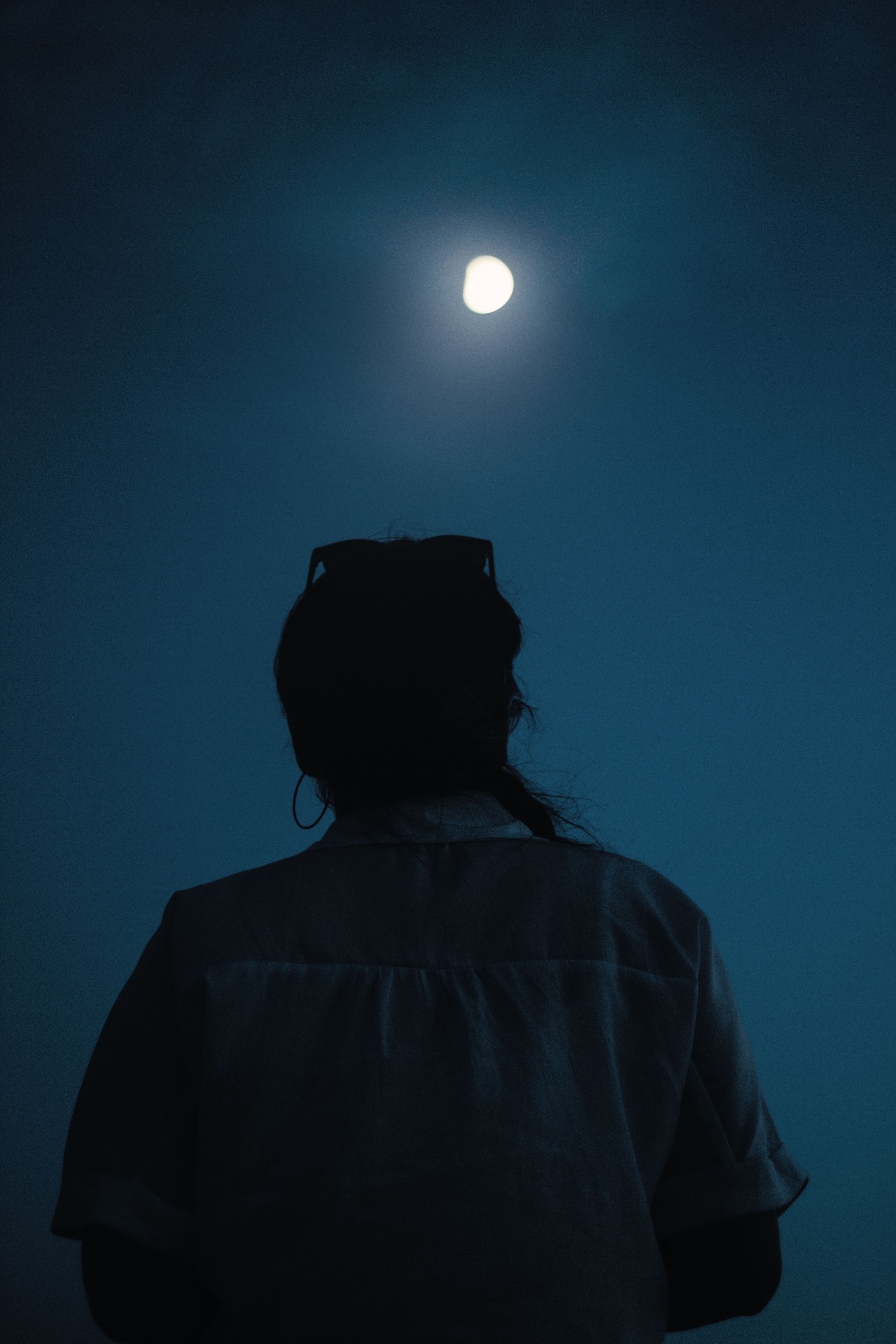 Woman Standing Under a Bright Moon · Free Stock Photo