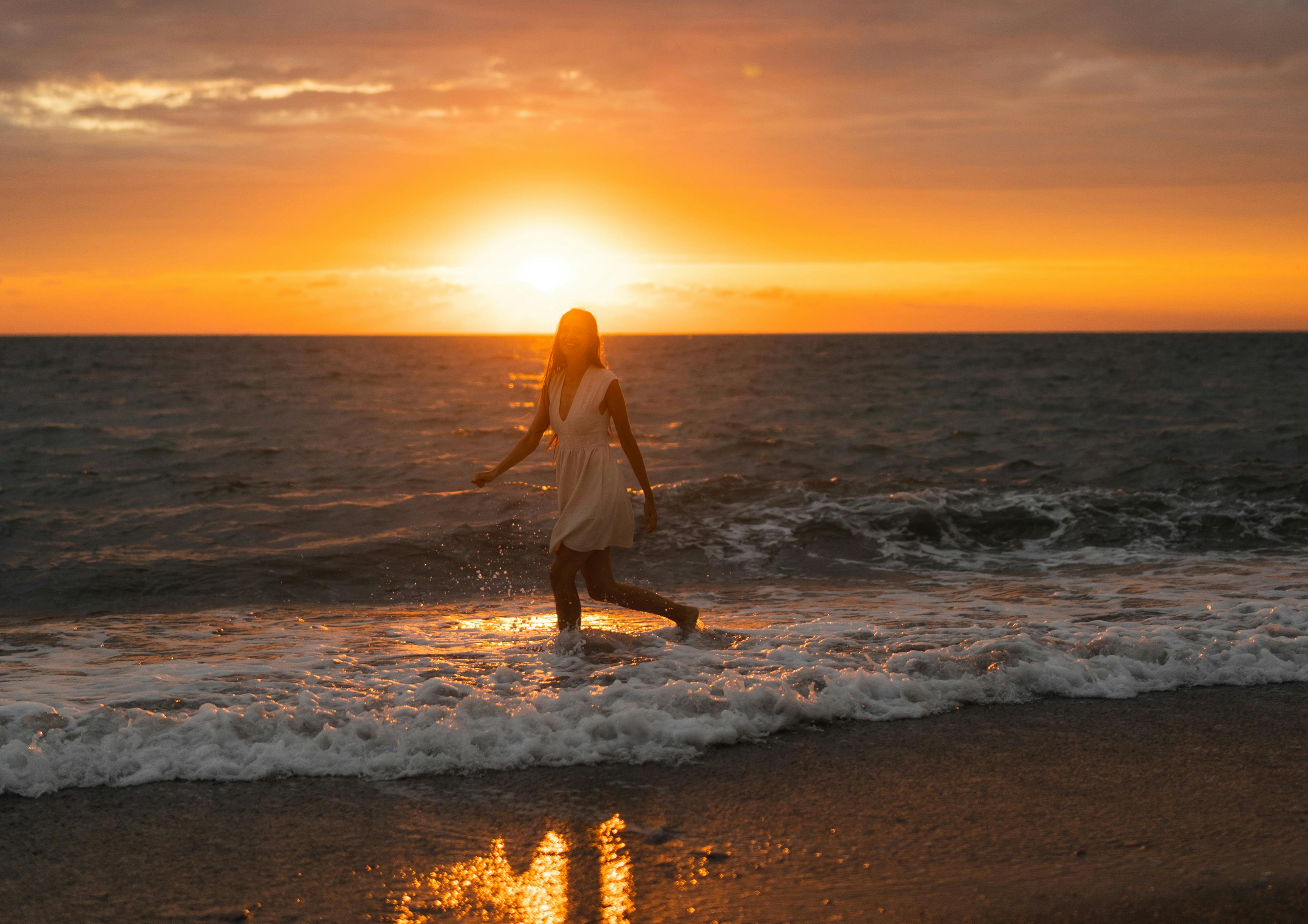 A Woman at the Beach During the Golden Hour · Free Stock Photo