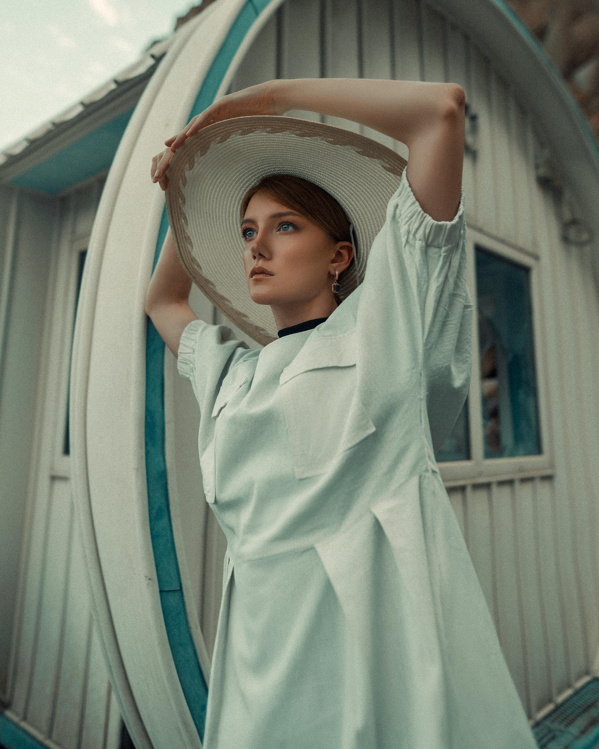 Woman in a Dress Posing with Her Arms Raised · Free Stock Photo