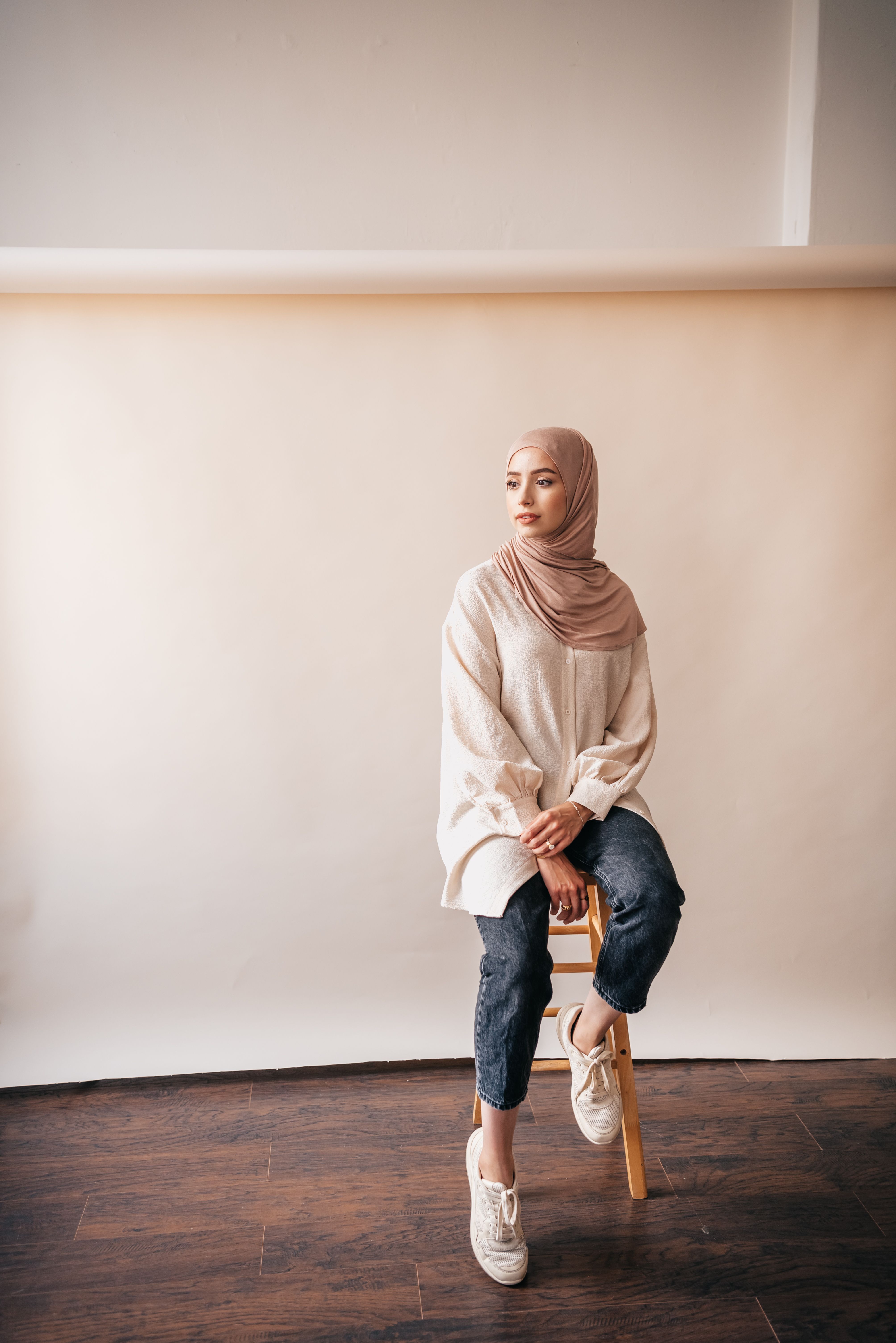 Woman in Beige Hijab Looking Away while Sitting · Free Stock Photo