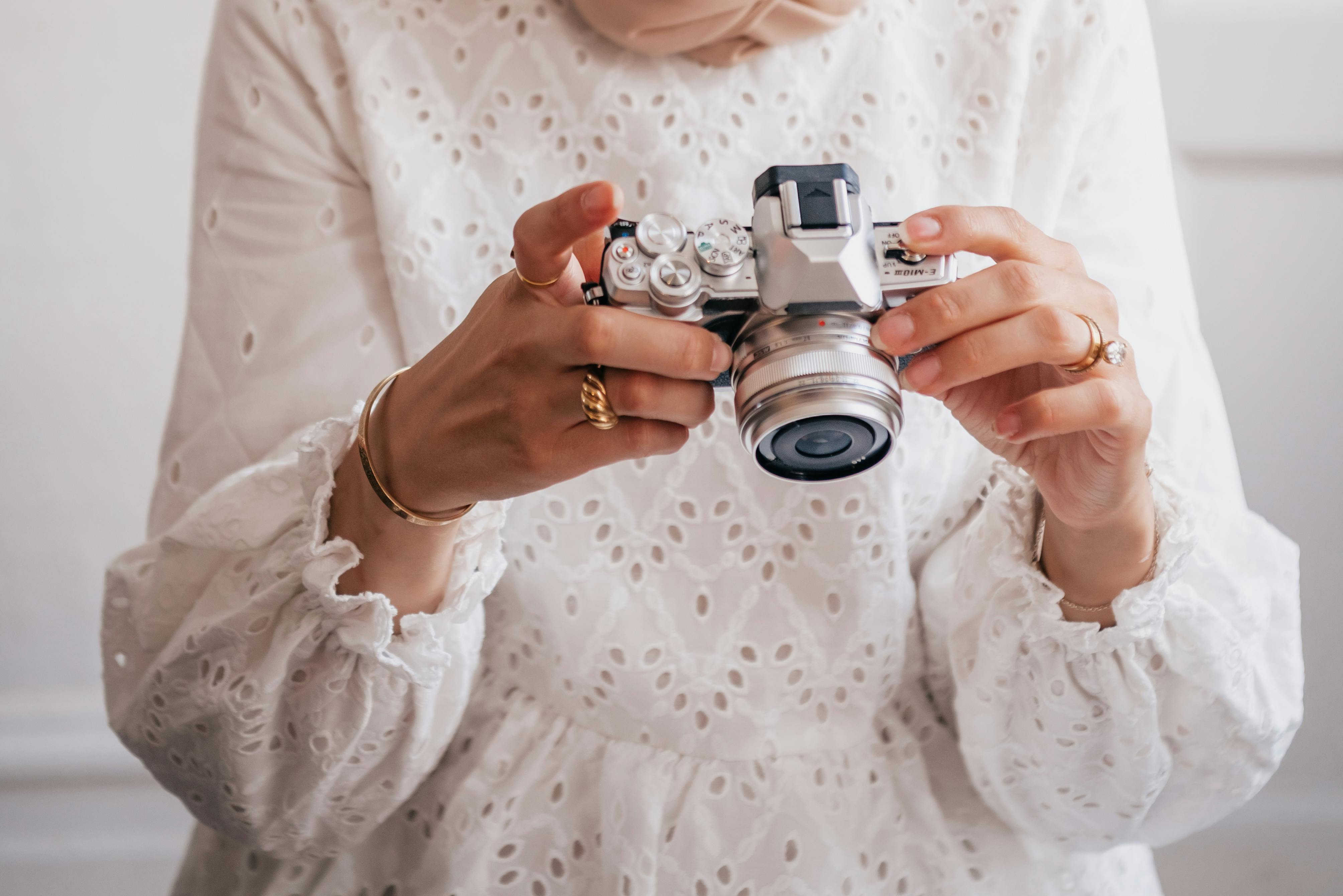 Close Up Photo of Person Holding a Camera · Free Stock Photo