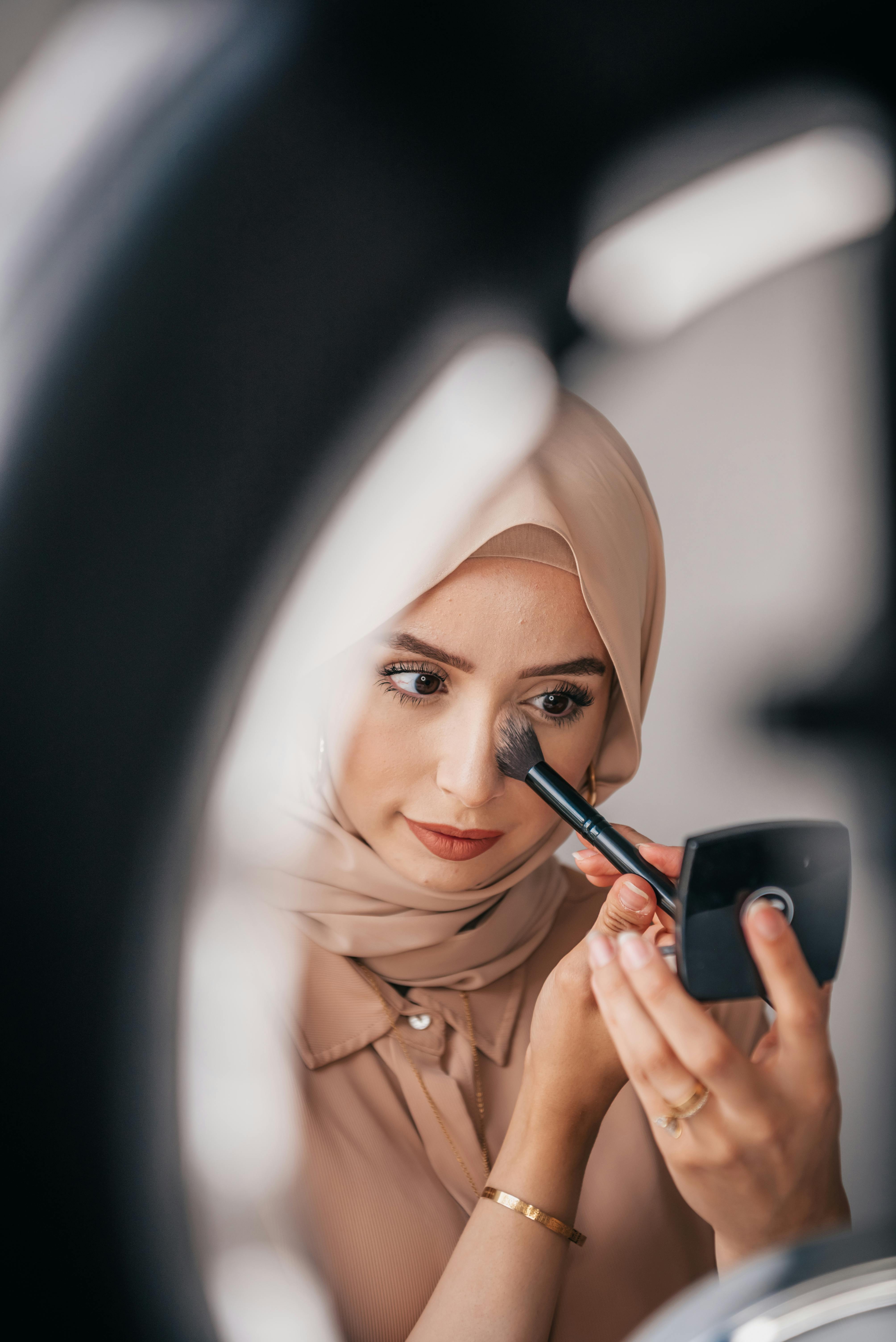 Woman in Hijab Applying Lipstick · Free Stock Photo