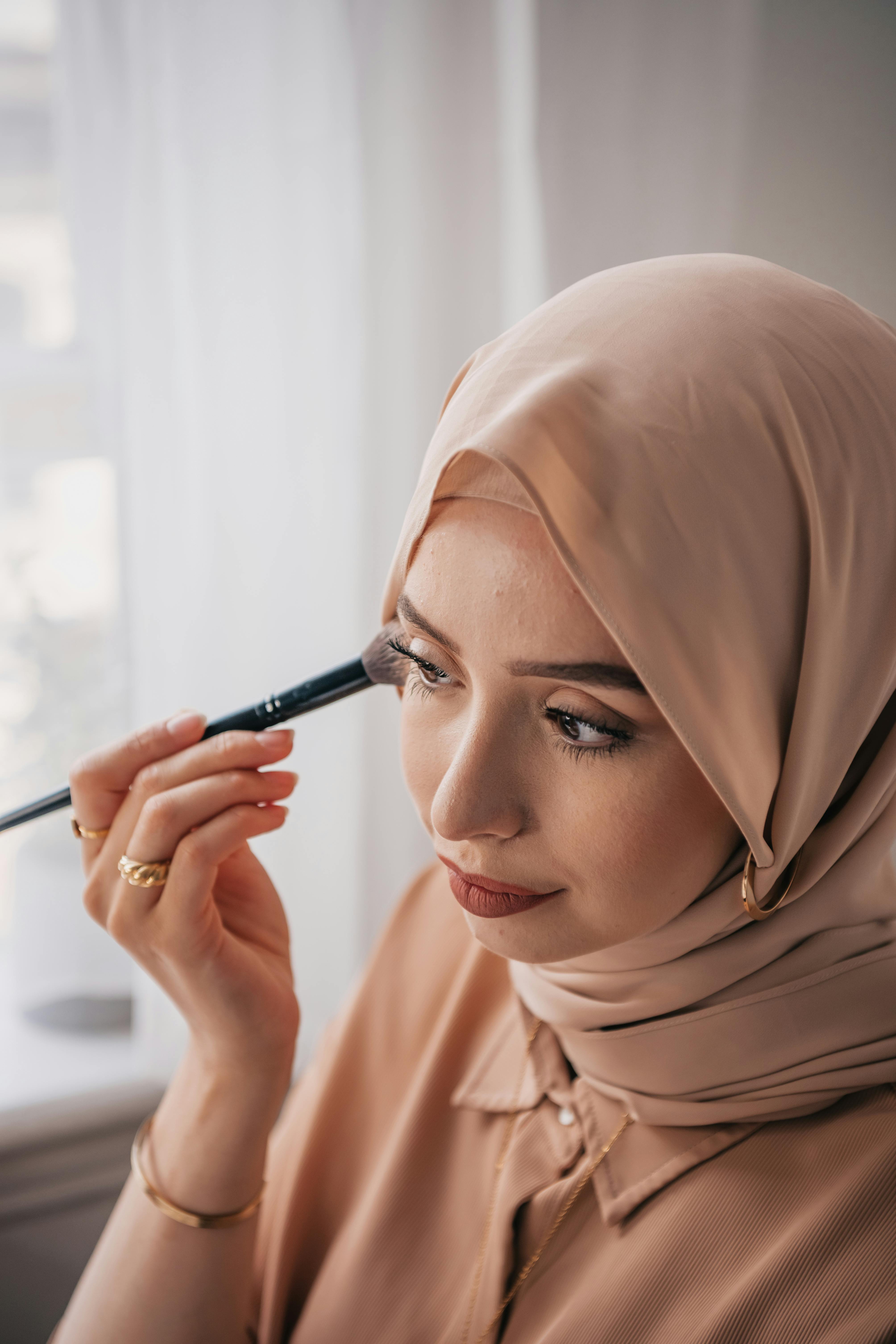 Woman Wearing Hijab Applying Makeup on Her Face · Free Stock Photo