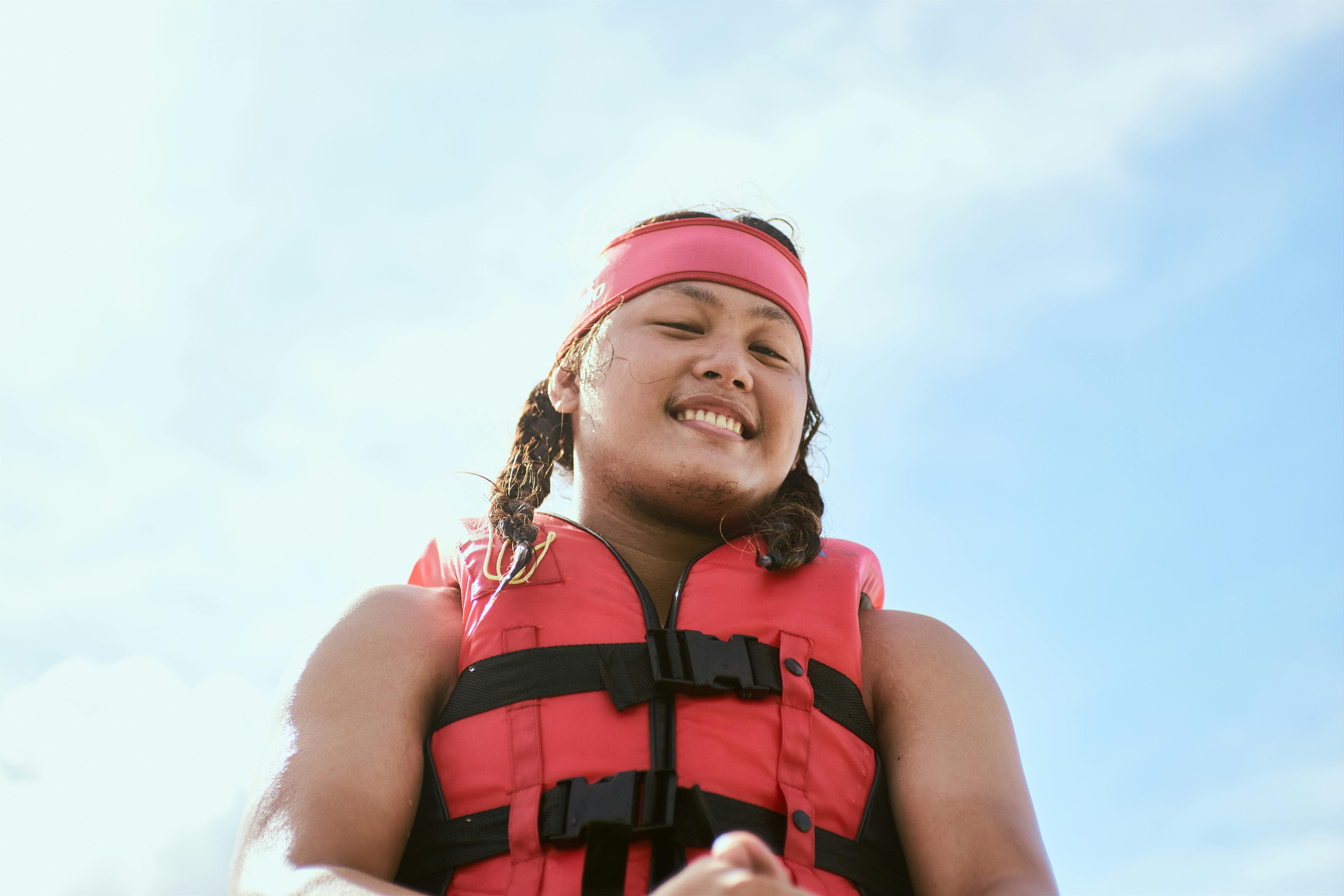 Man in Red and Black Life Vest With Red Sports Sweatband · Free Stock Photo
