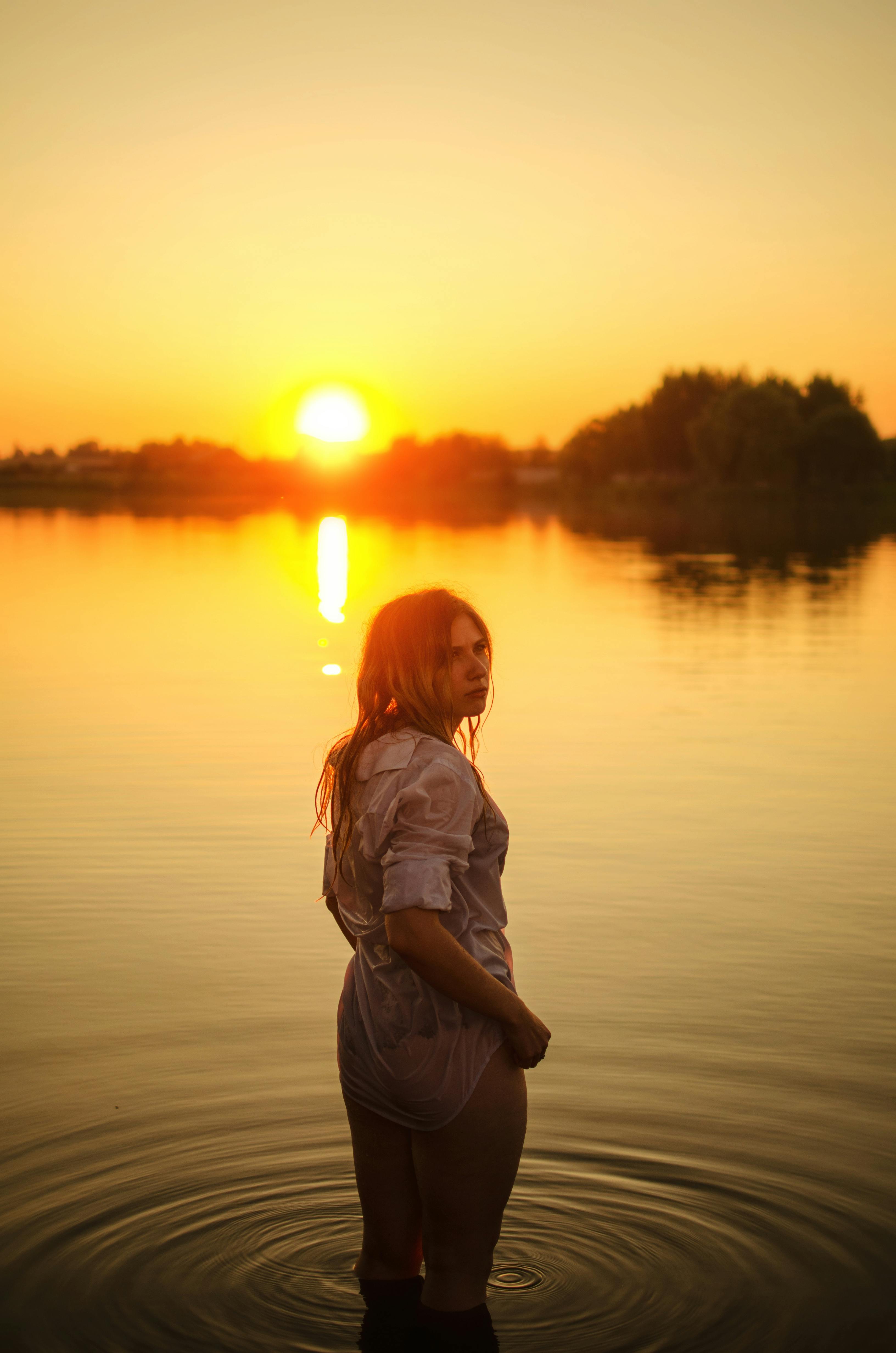 Woman on Body of Water Looking Back · Free Stock Photo