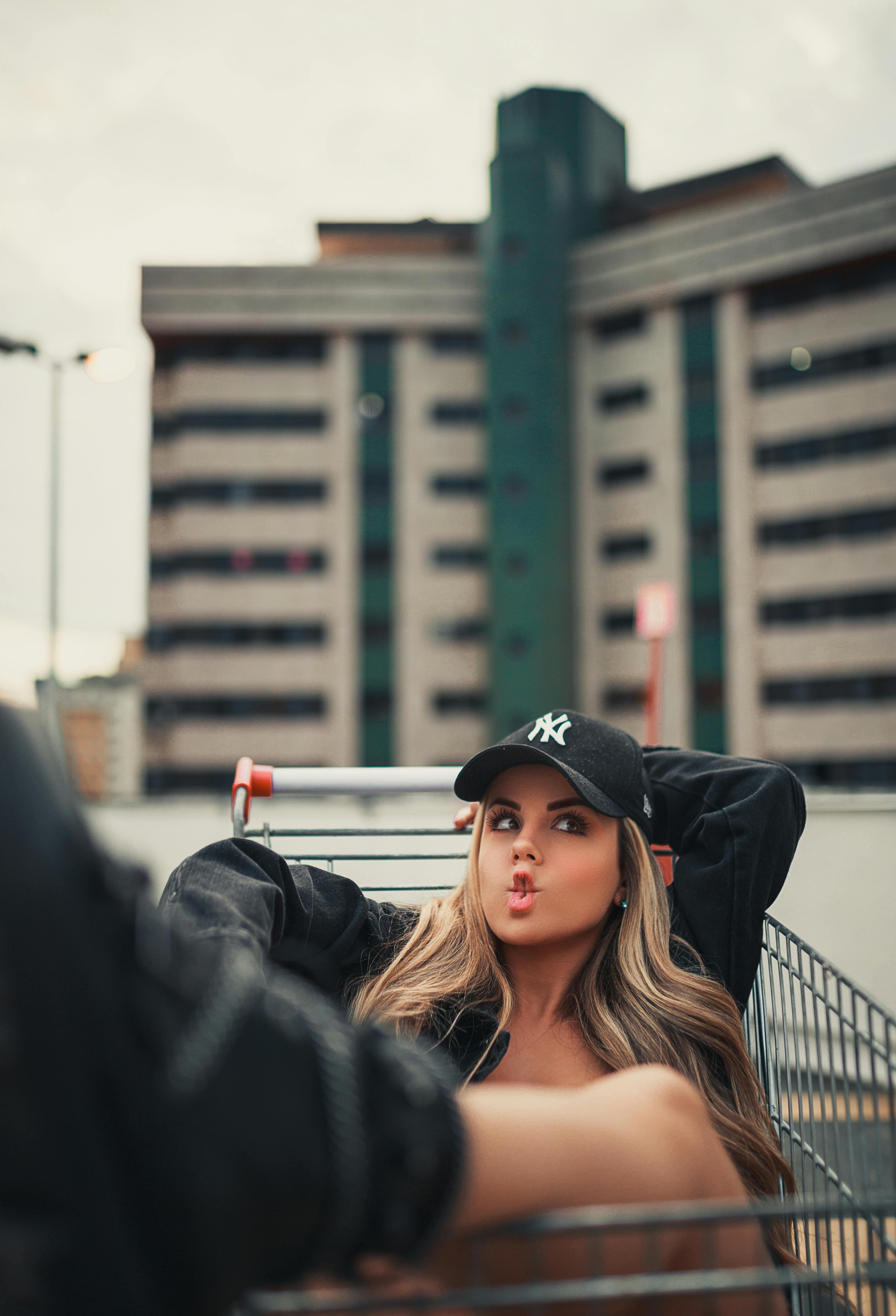 Woman Pushing a Push Cart Dolly · Free Stock Photo