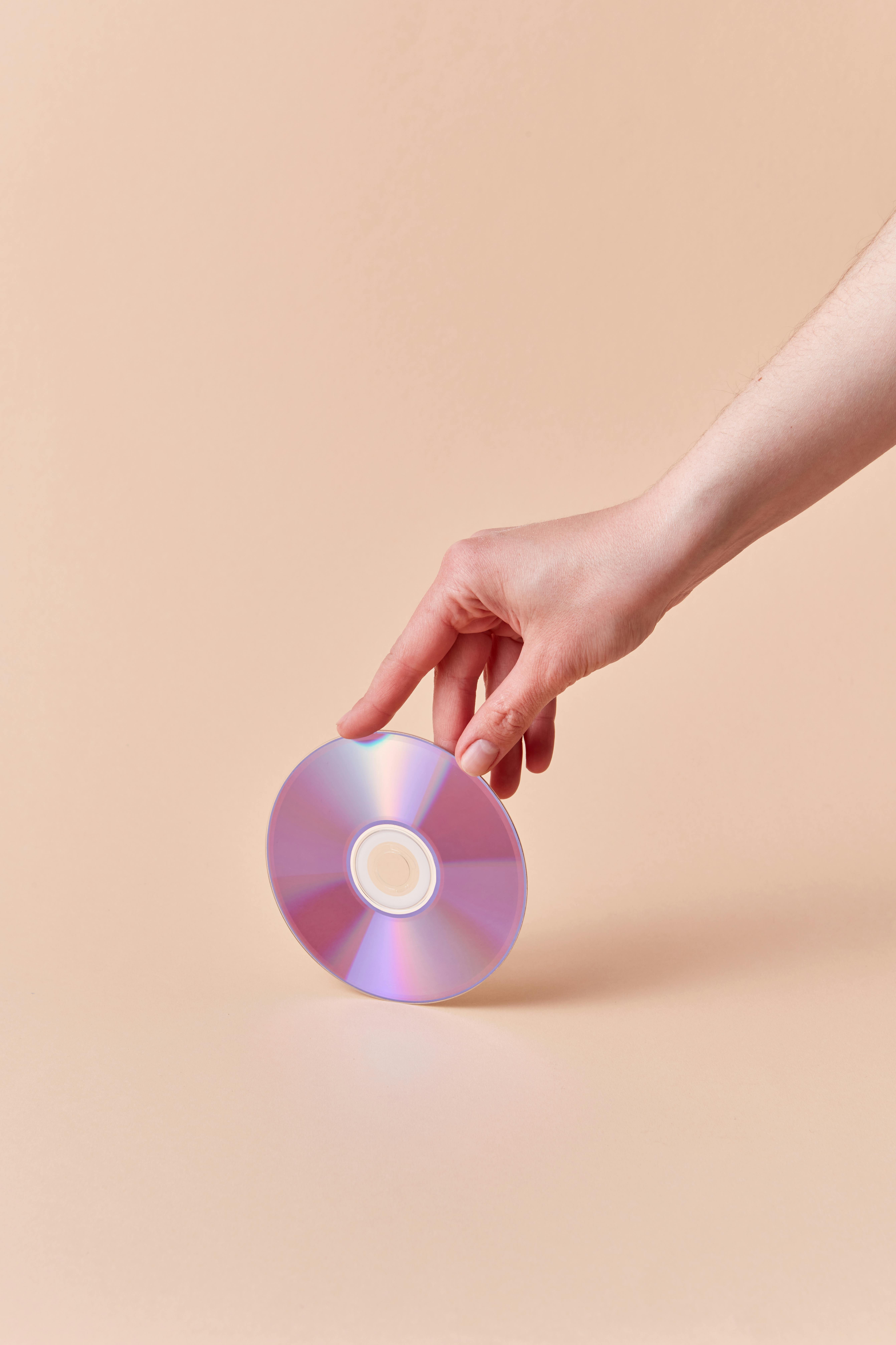 A Person Holding a Compact Disc · Free Stock Photo