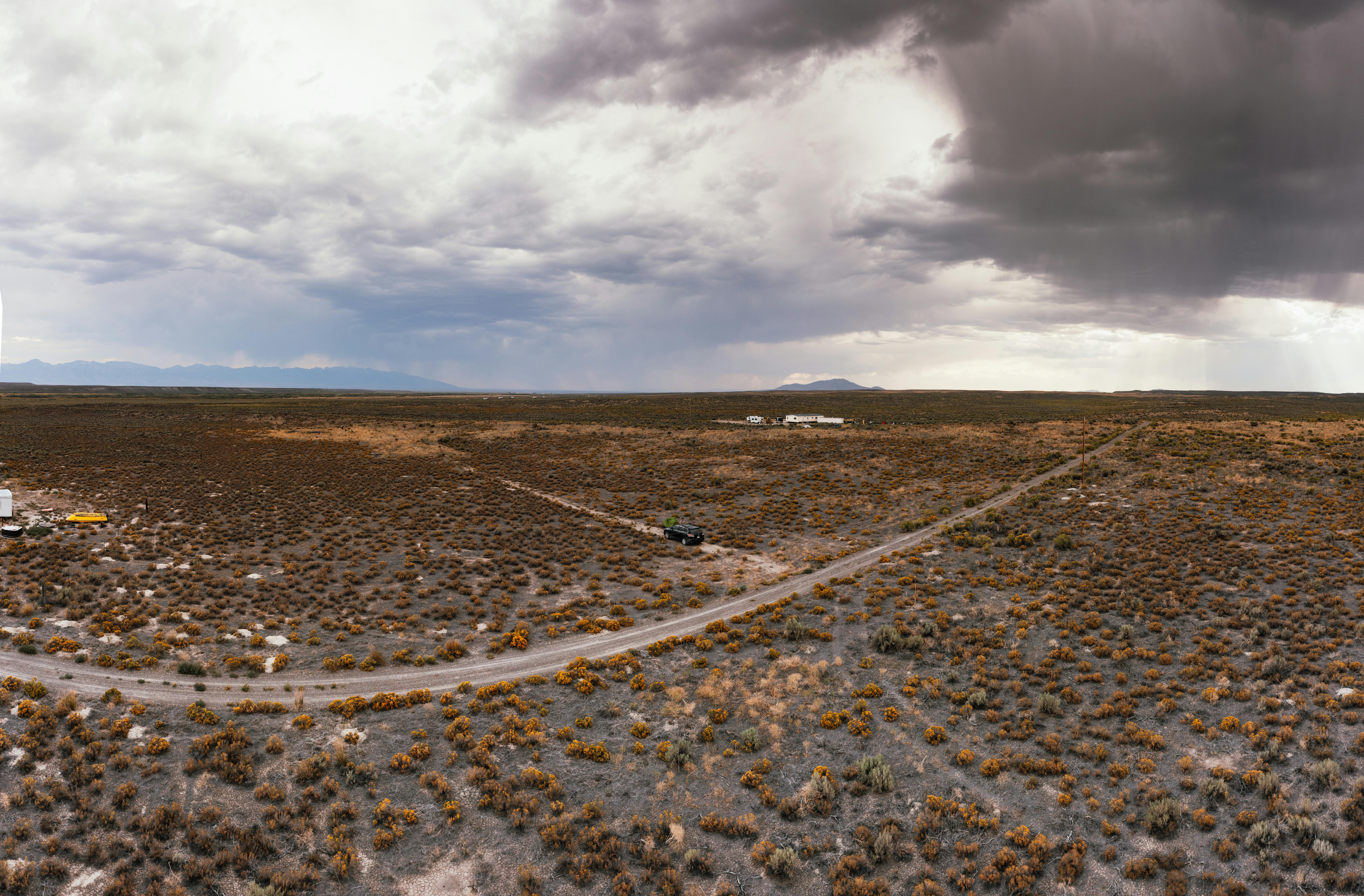 Aerial View of a Road Through a Desert and Water in Distance · Free ...