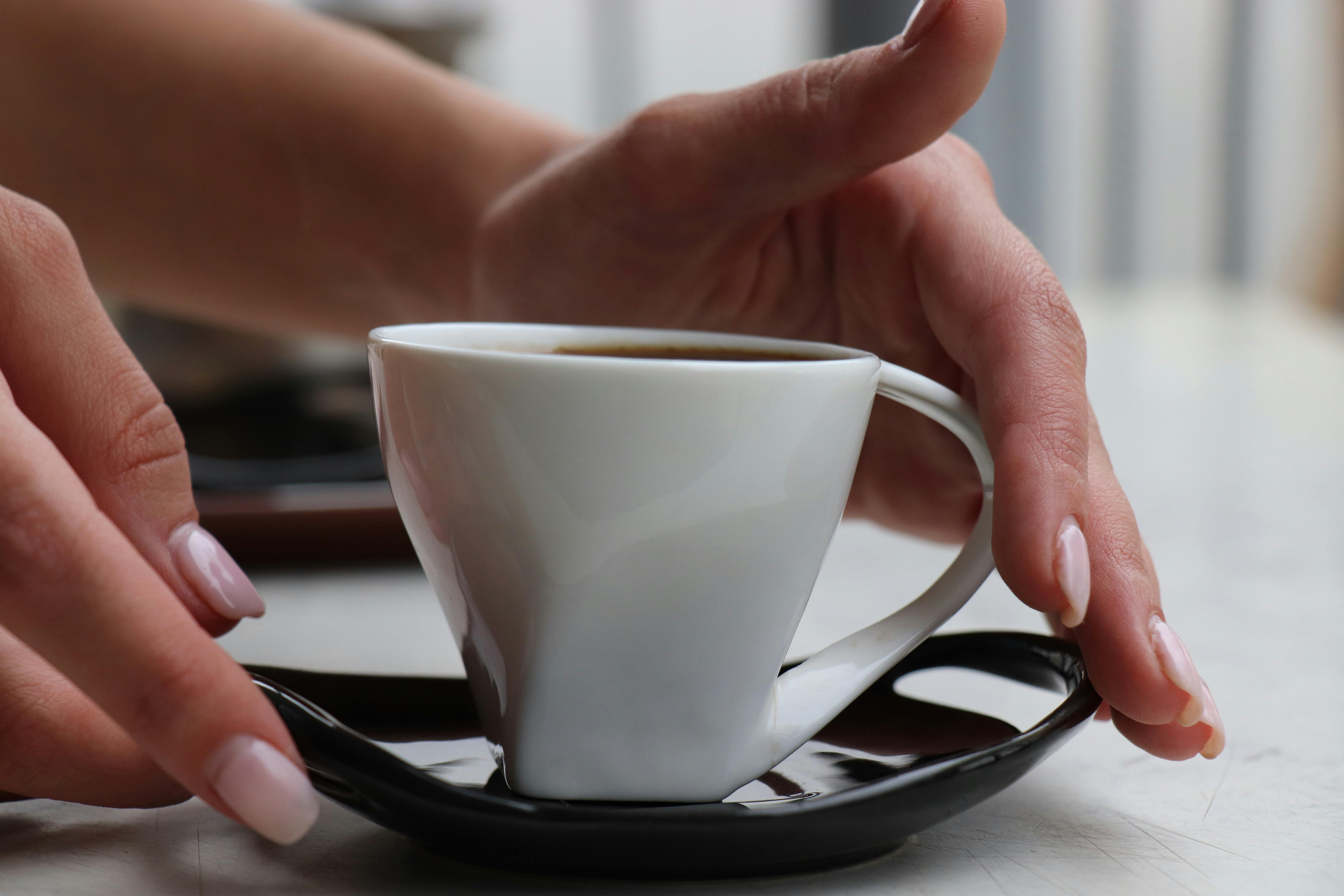 Elderly Woman Putting on the Table a Cup · Free Stock Photo