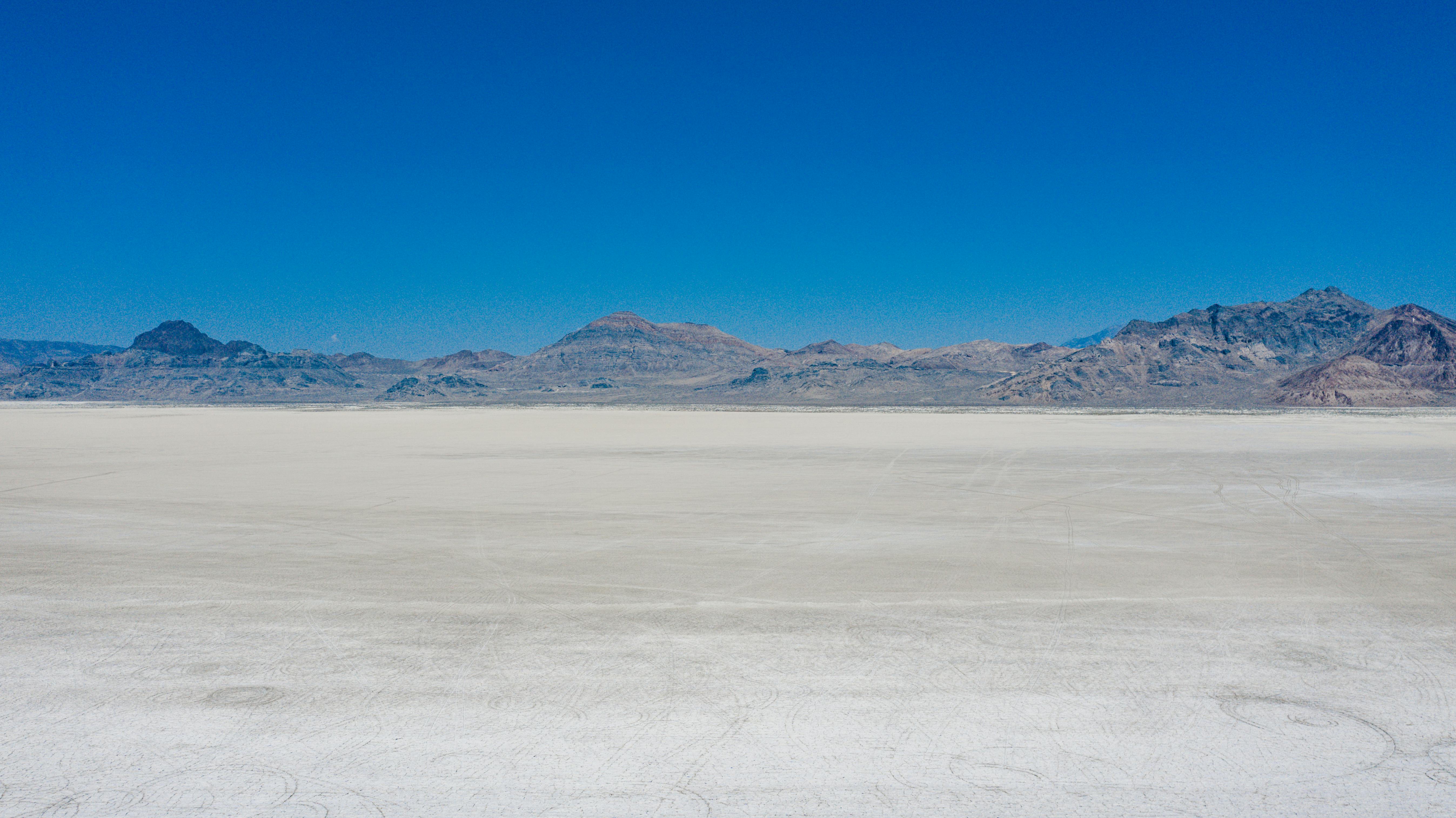 Photo of a Barren Desert Near Mountains · Free Stock Photo
