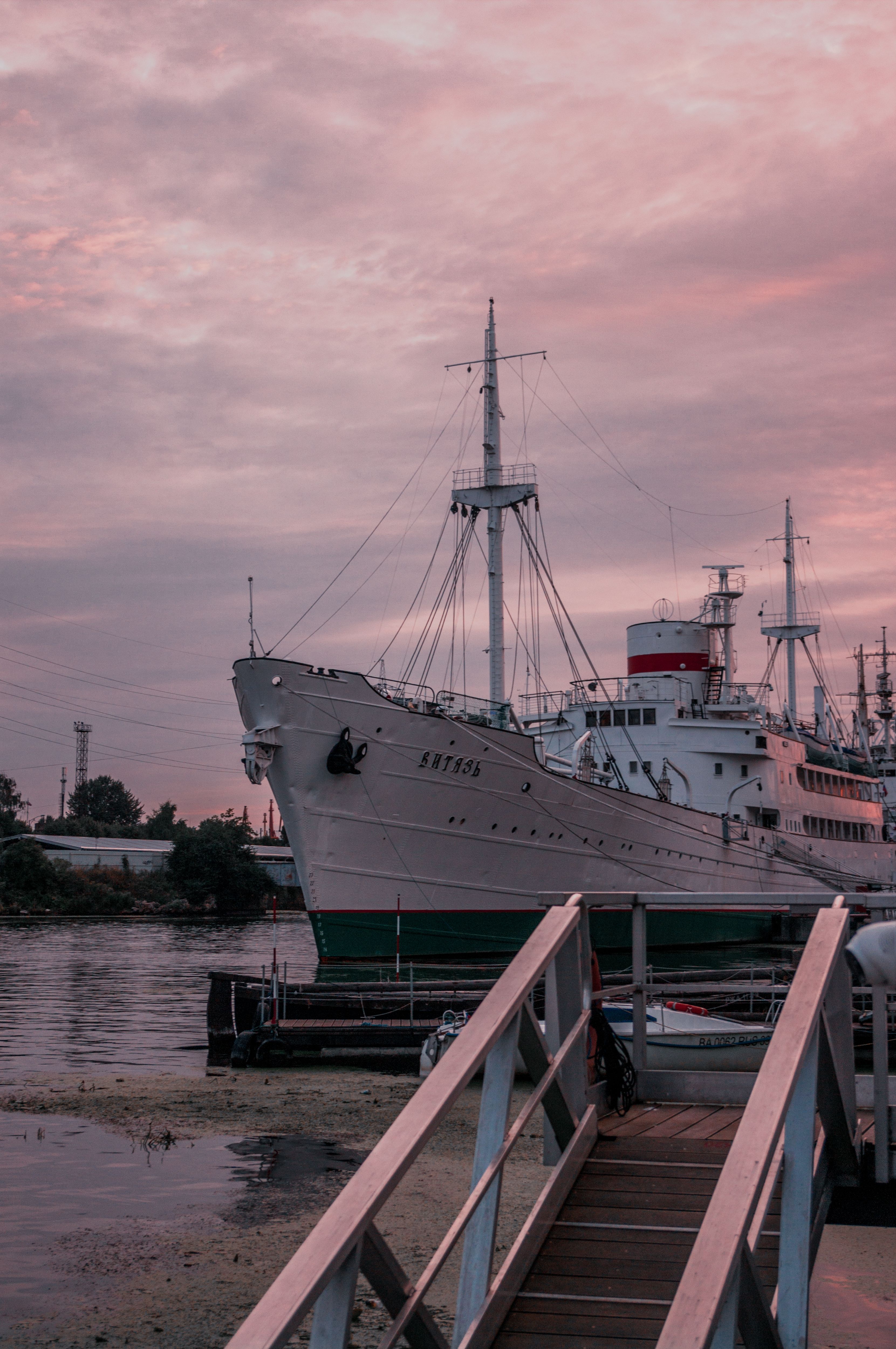 Man Riding Bike Beside Ship · Free Stock Photo