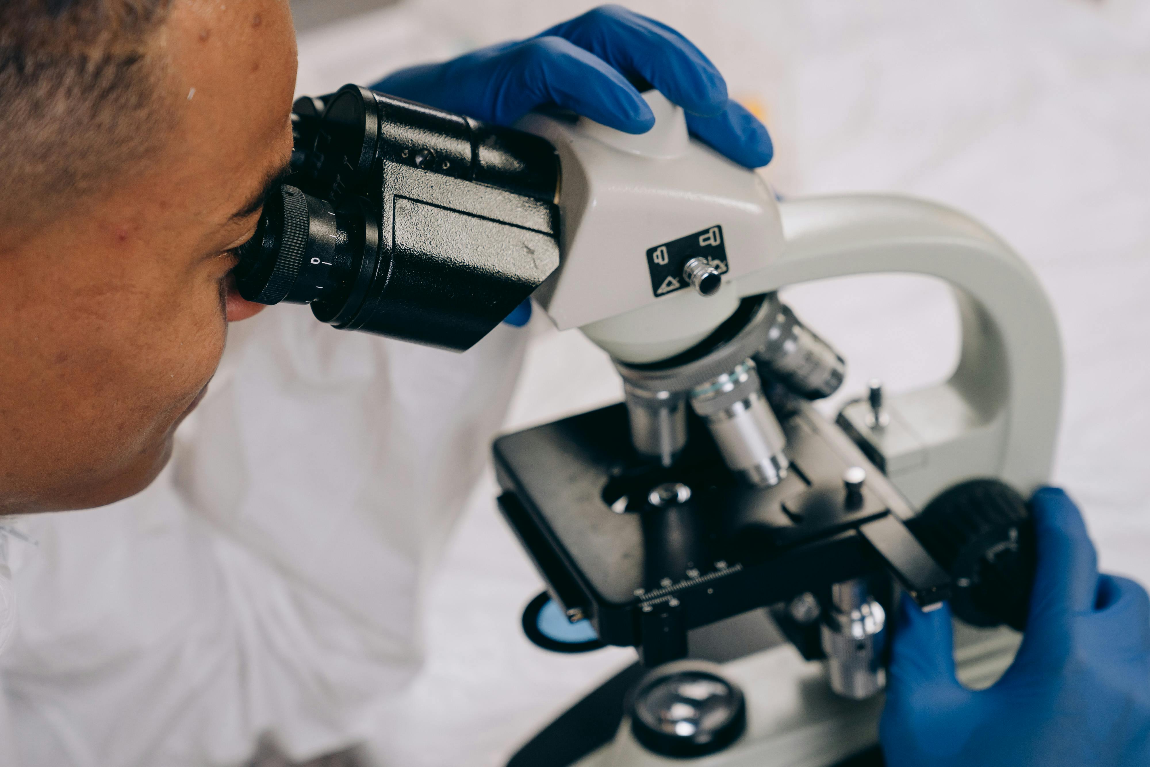 A Man Using a Microscope · Free Stock Photo