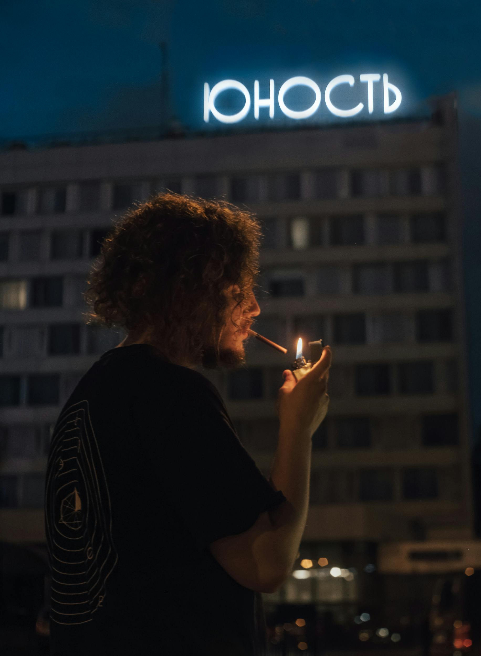 Man Smoking Cigarette on City Street · Free Stock Photo