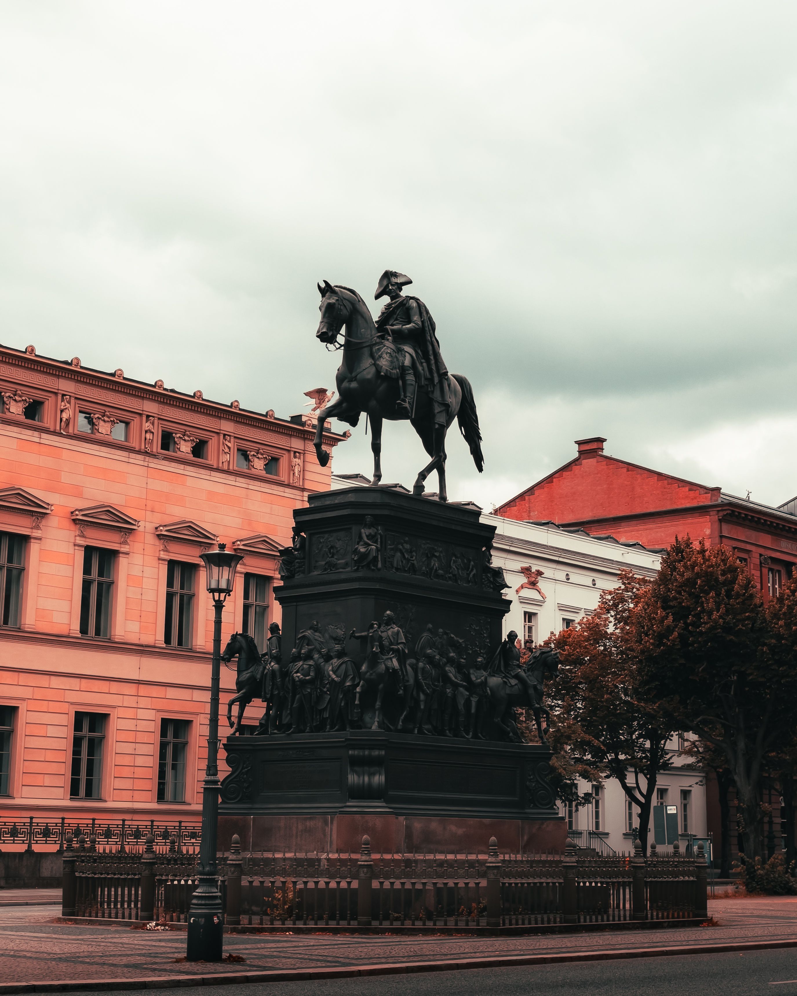 Bronze Sculpture on Building Wall · Free Stock Photo