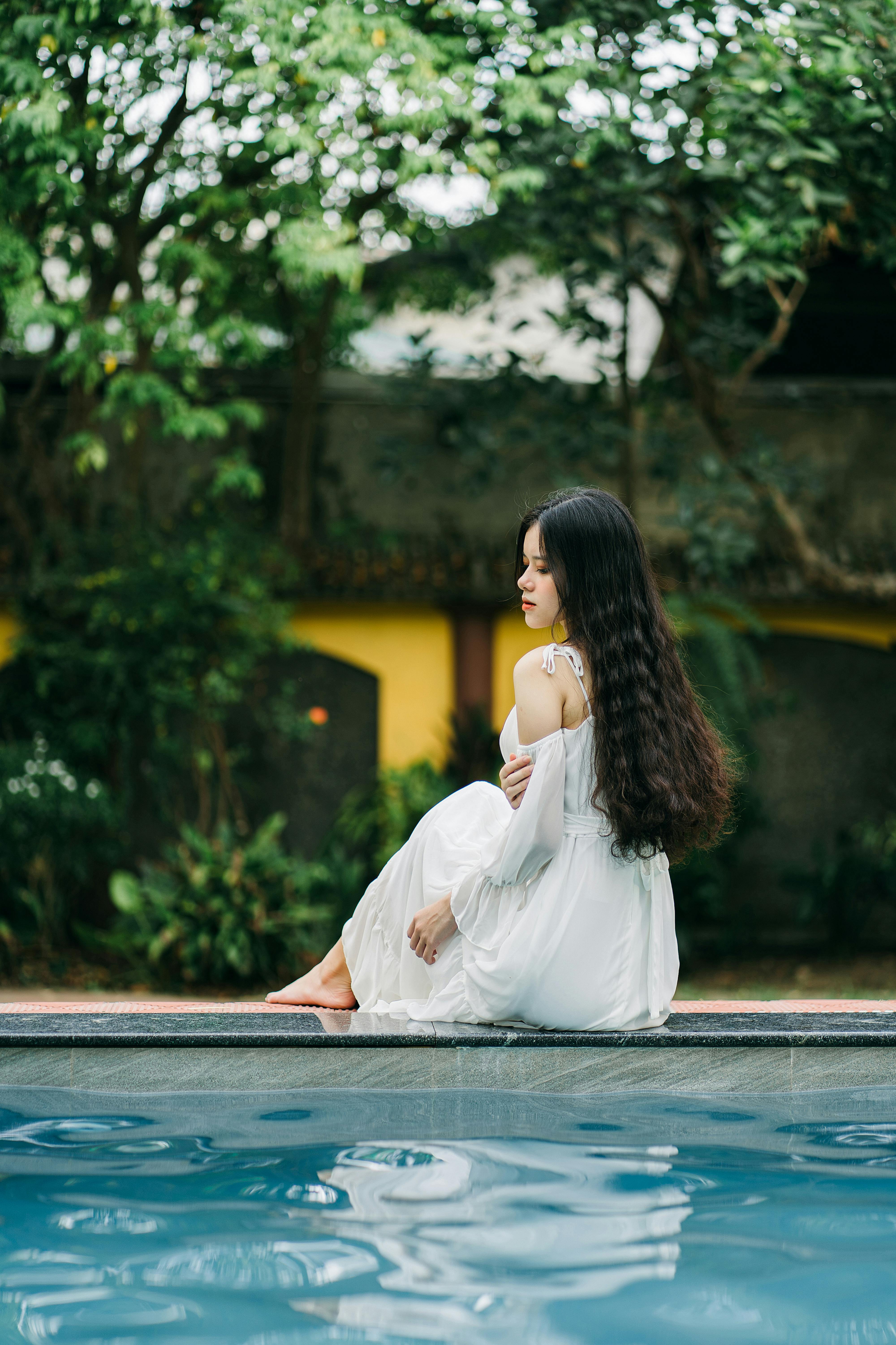 Lady in White Traditional Dress Standing on Footpath · Free Stock Photo