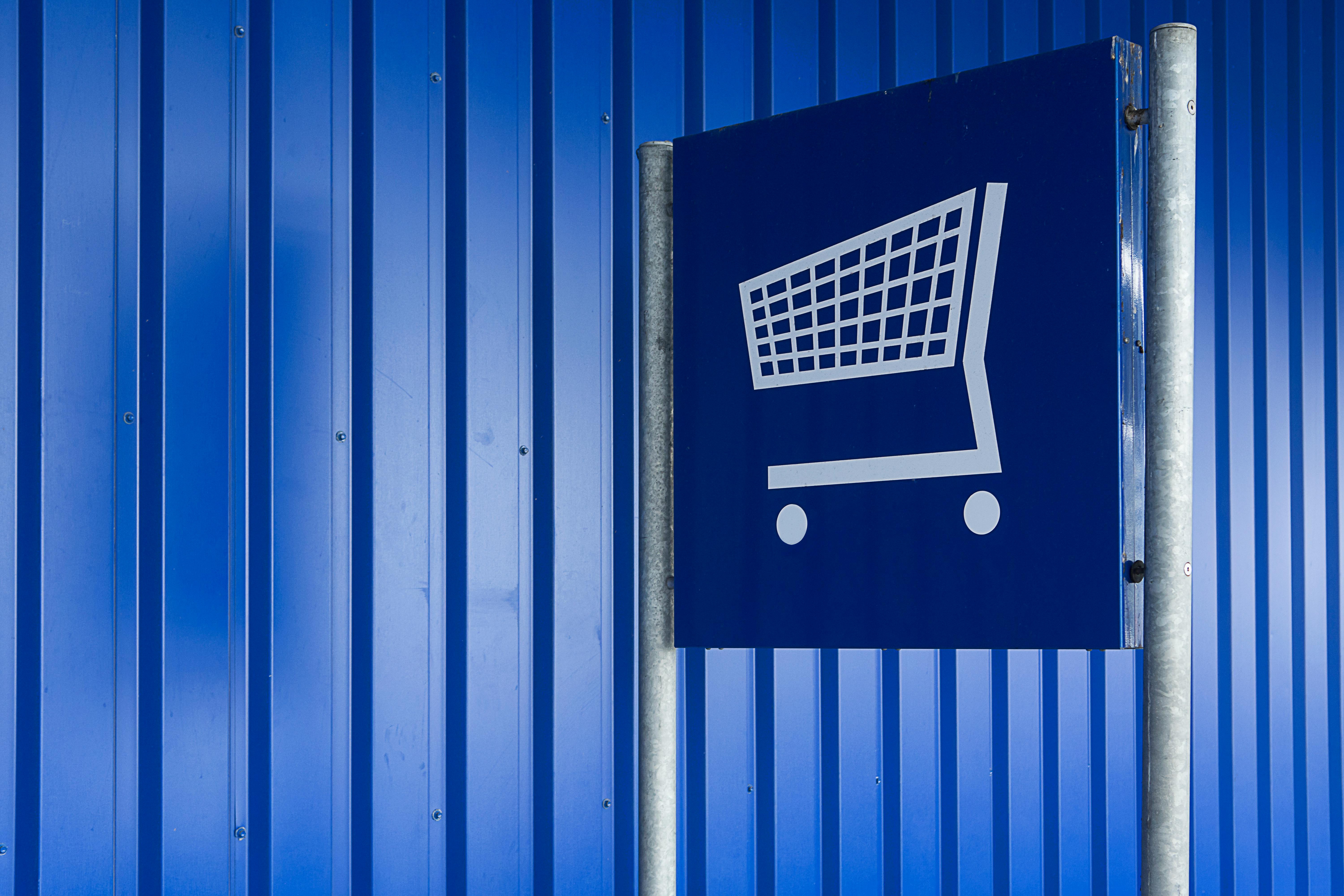 Shopping Cart on a Blue Signage · Free Stock Photo