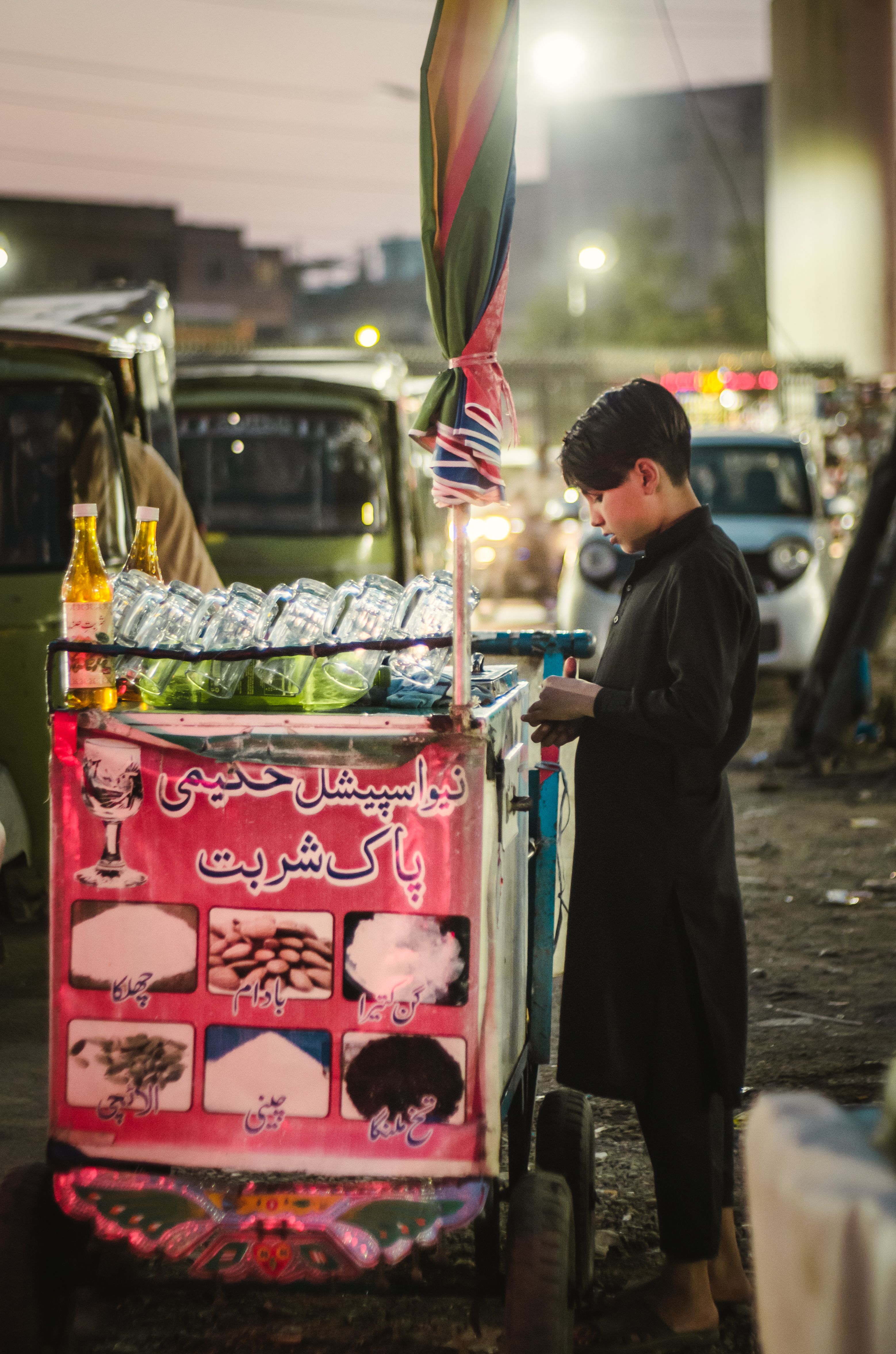Young Boy Standing Behind a Stall Selling · Free Stock Photo