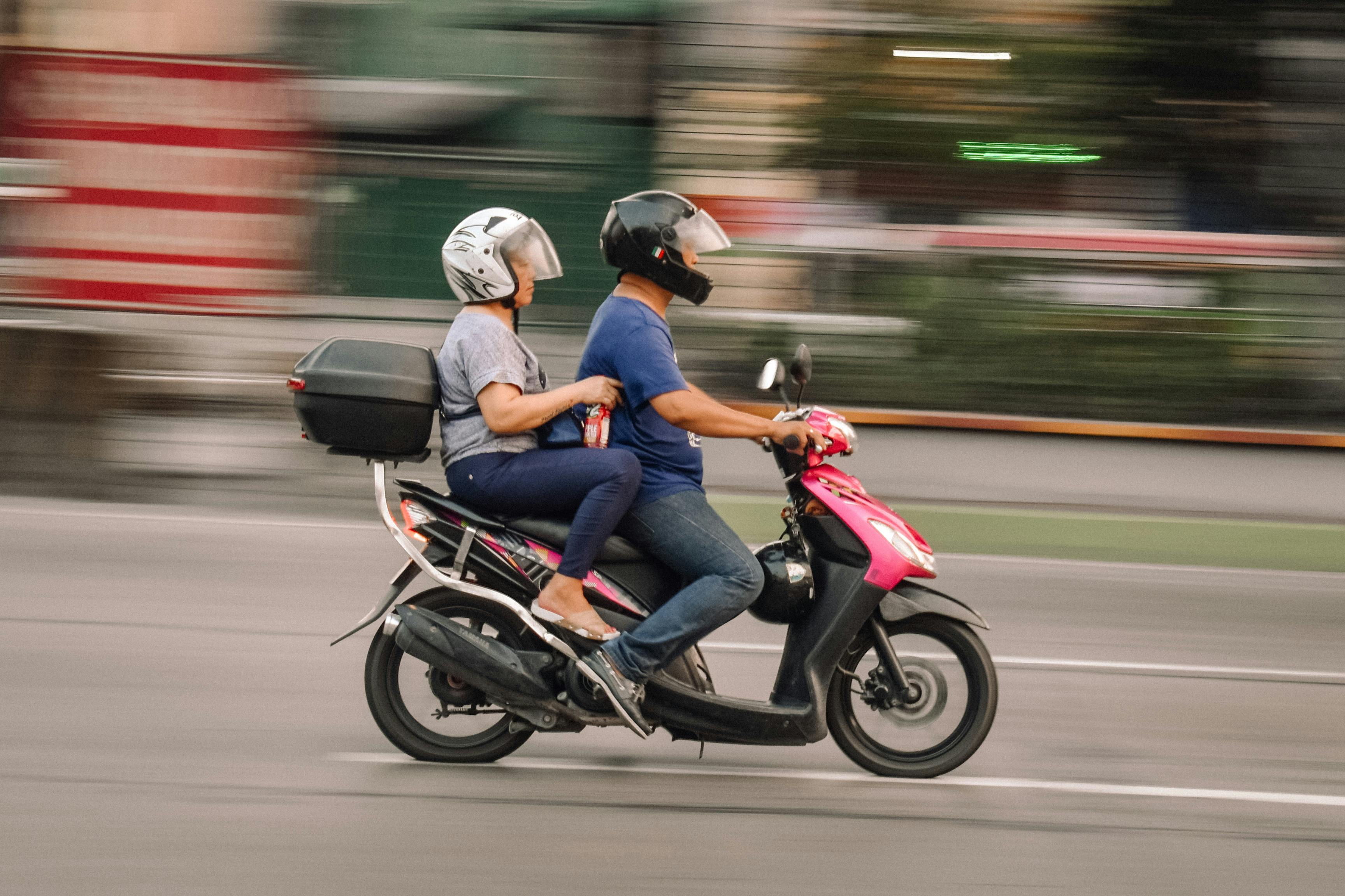 Photo of Person Riding a Scooted on Sidewalk · Free Stock Photo
