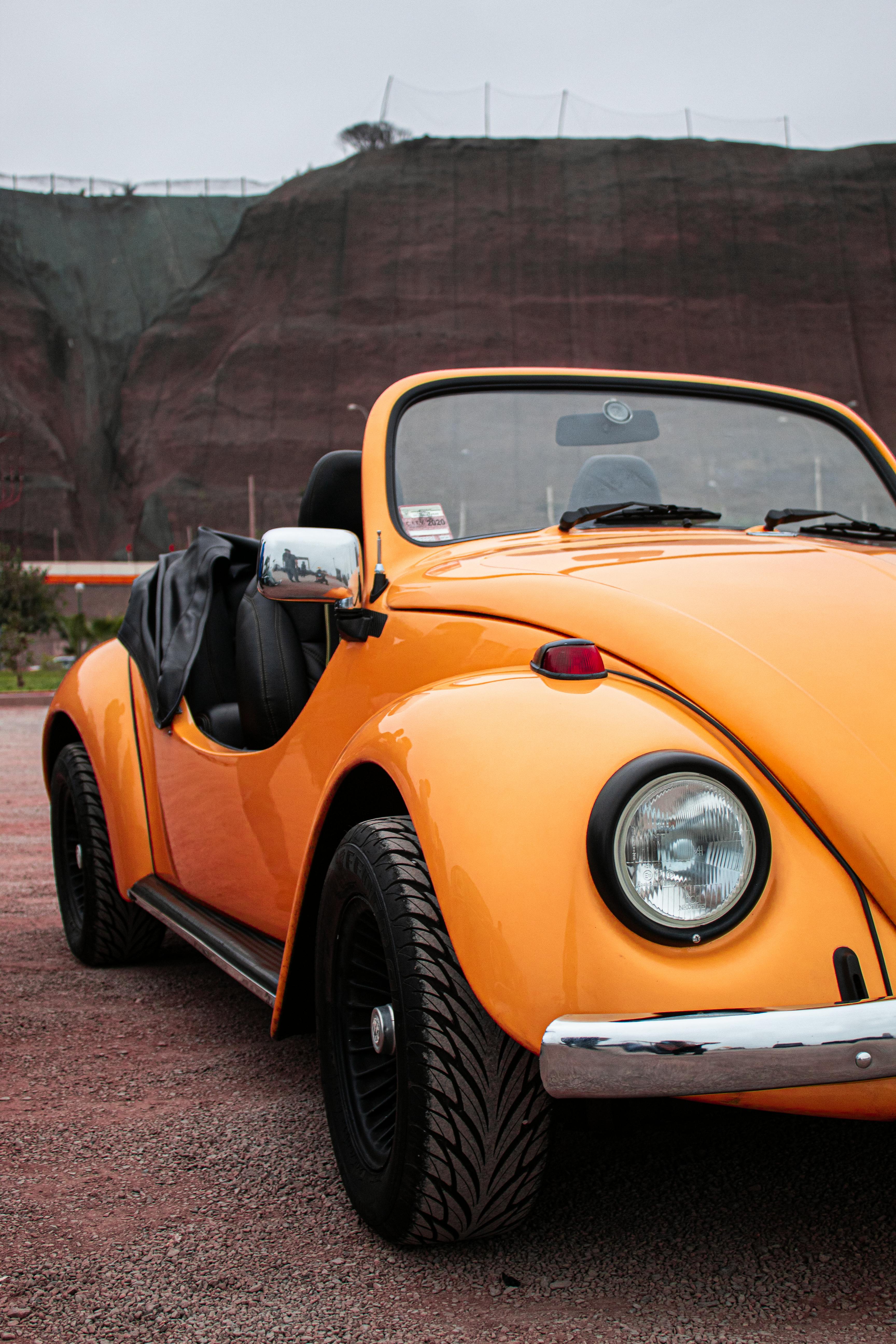 An Orange Vintage Car Parked on the Road · Free Stock Photo