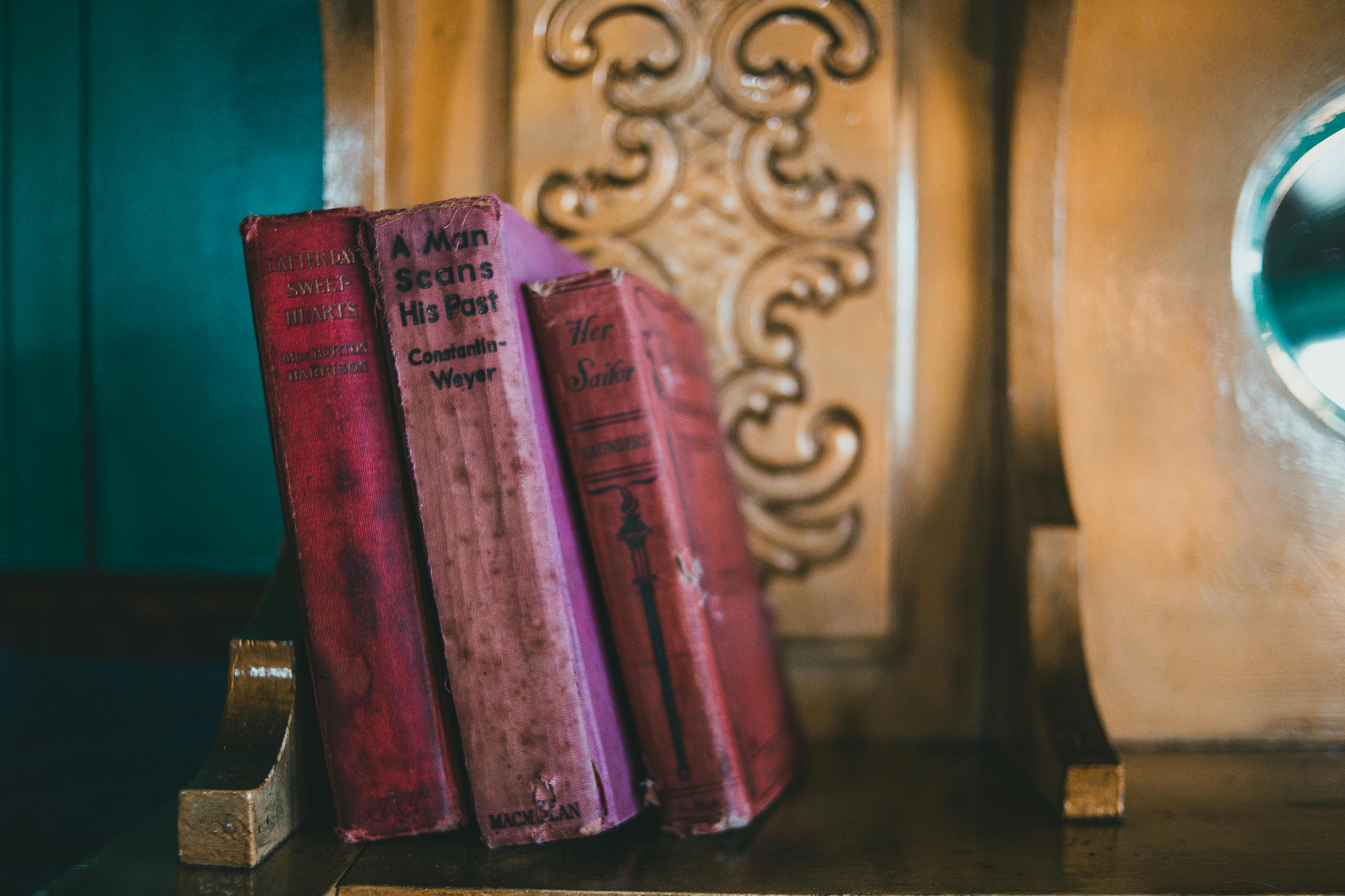 Purple Vintage Books on a Shelve · Free Stock Photo