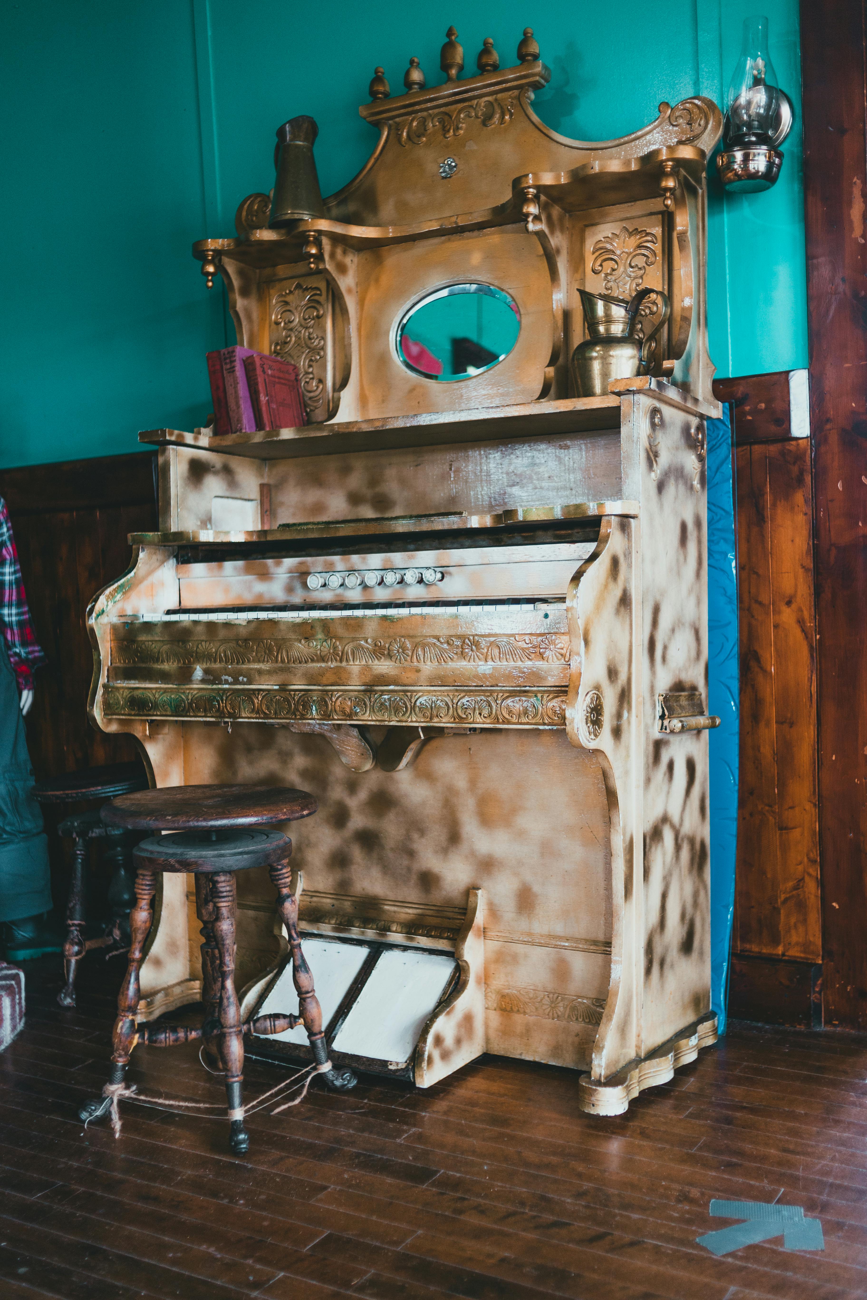 Antique Piano Standing Indoors · Free Stock Photo