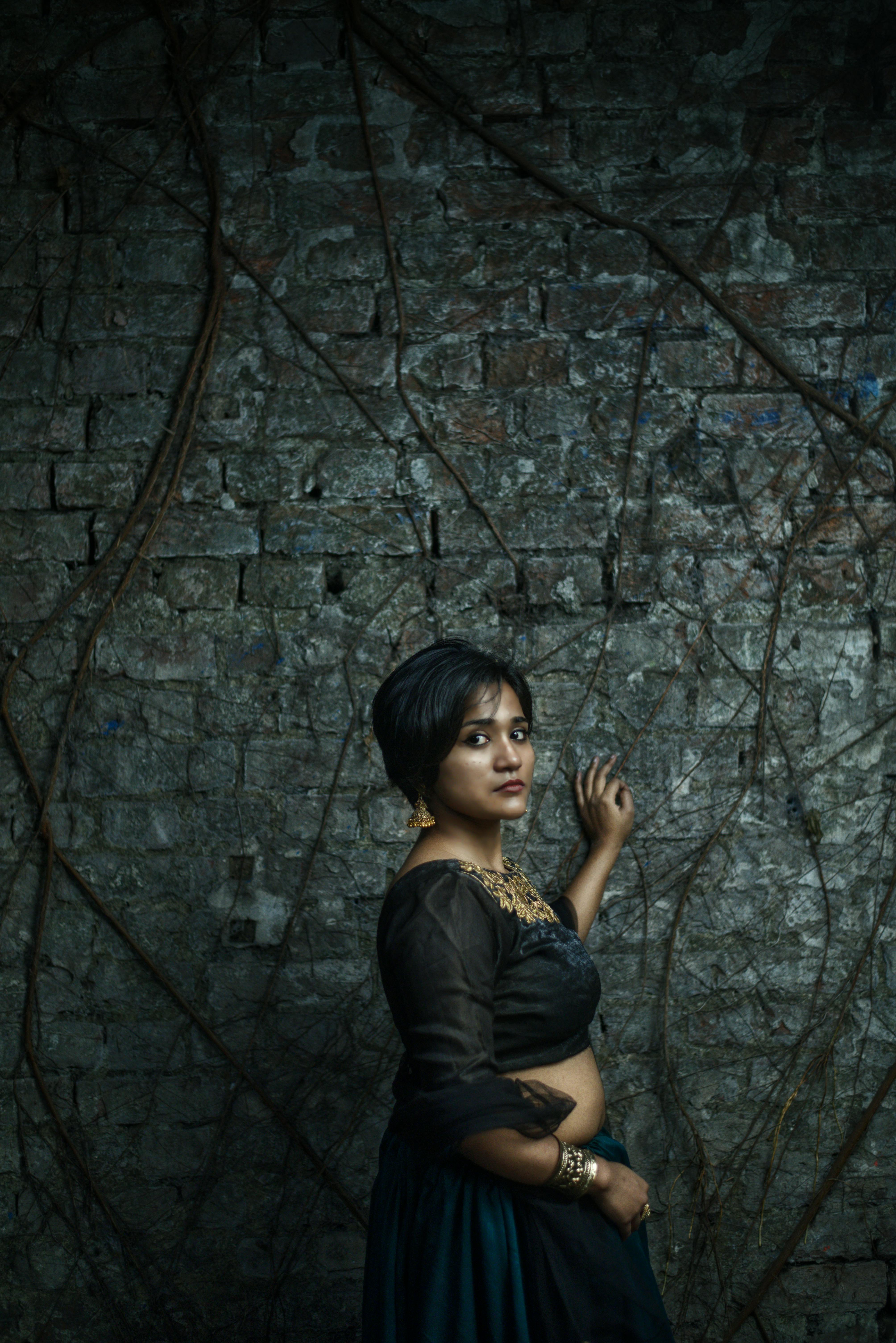 Portrait of a Woman Standing next to a Wall · Free Stock Photo