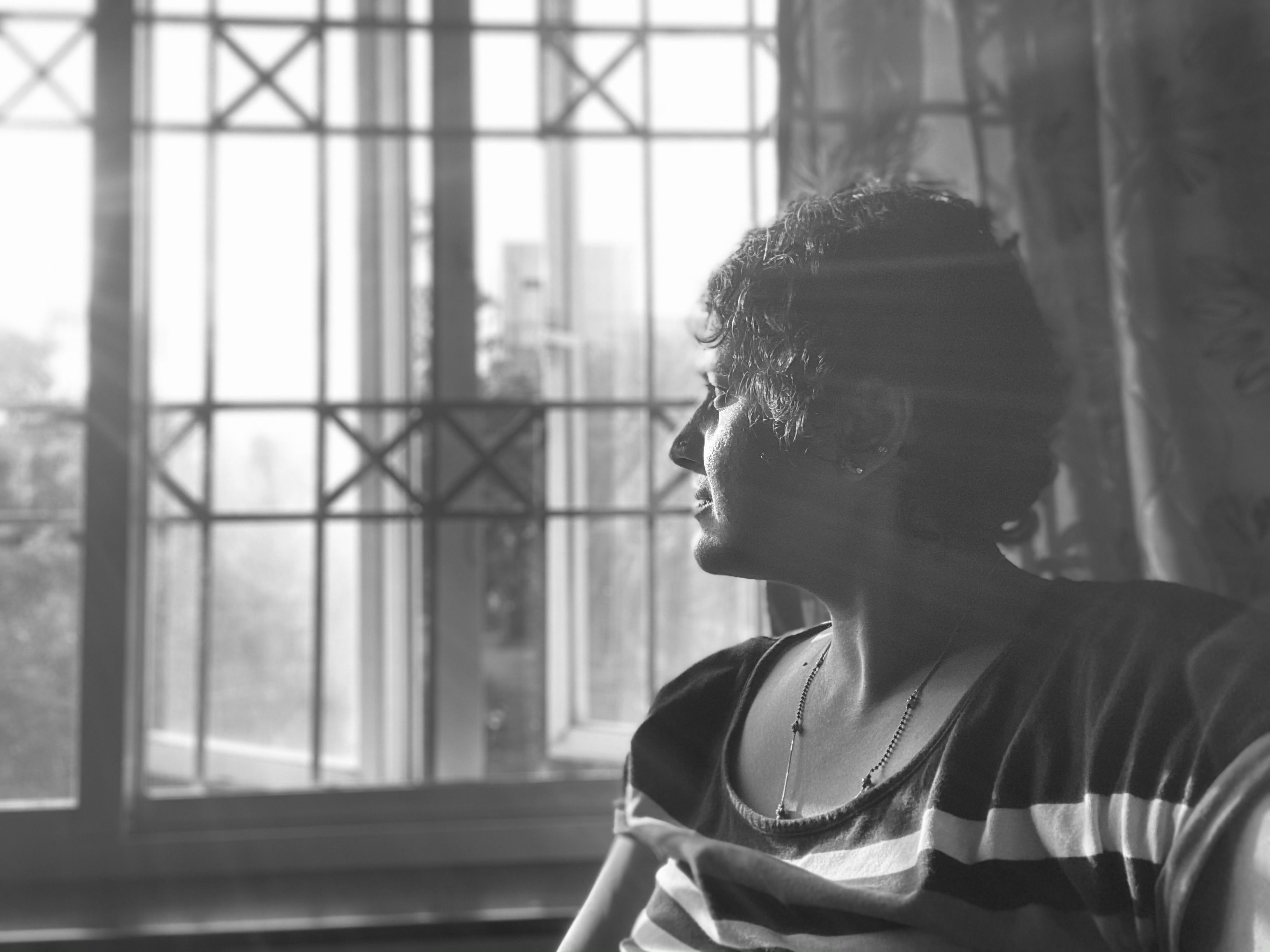 A Woman Sitting Beside the Window · Free Stock Photo