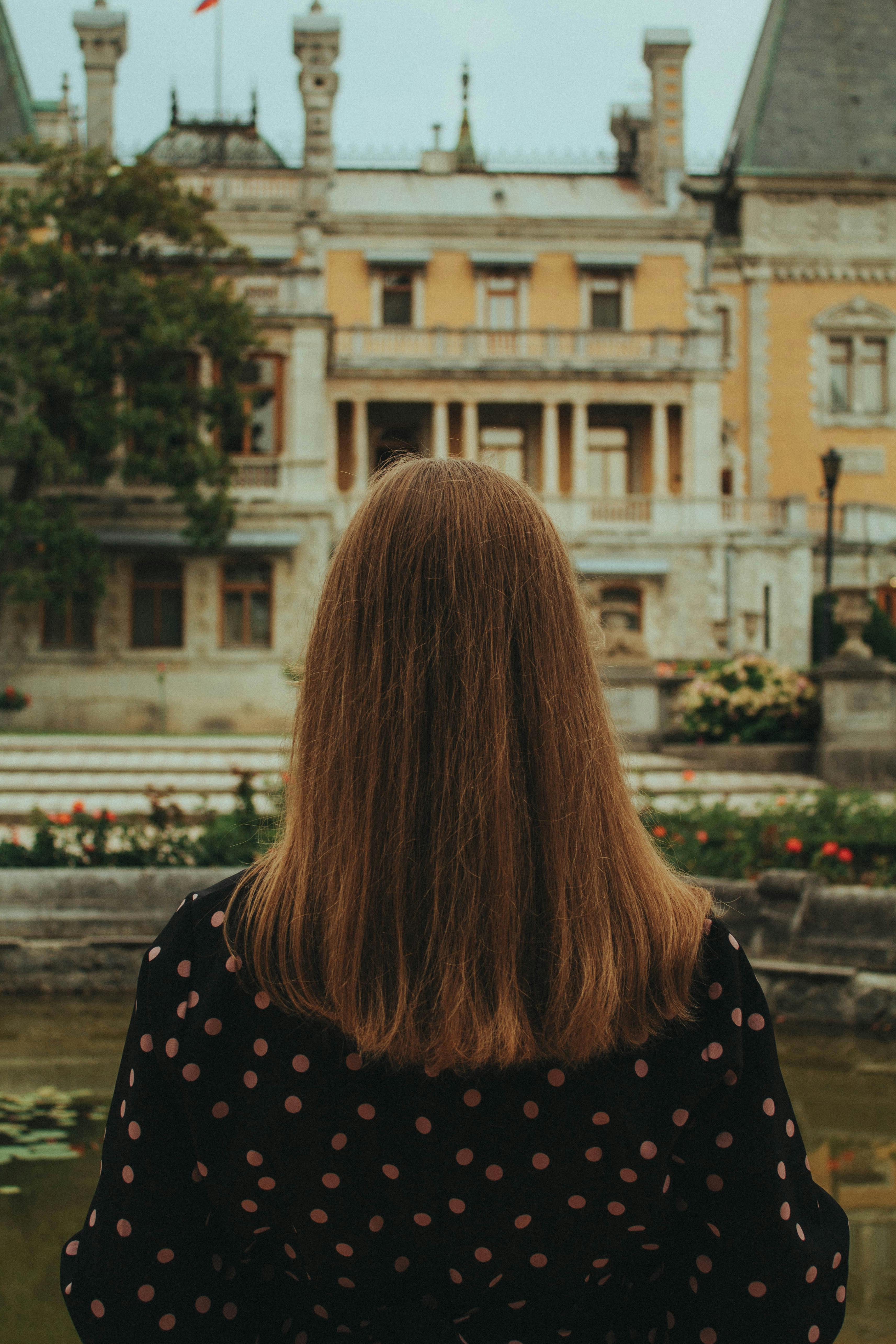 Back View of a Girl Holding Hat · Free Stock Photo