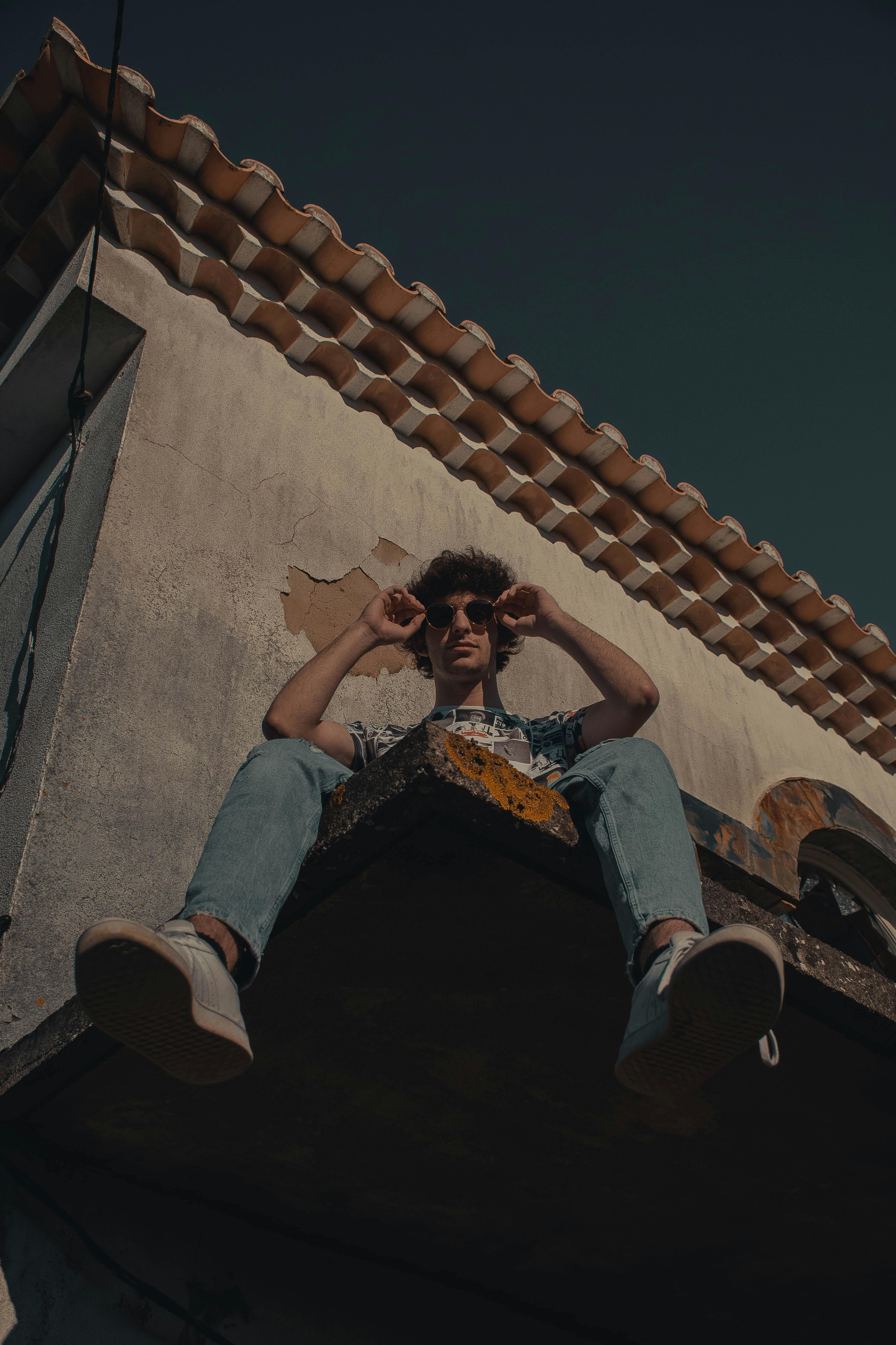 Man Sitting on the Roof · Free Stock Photo