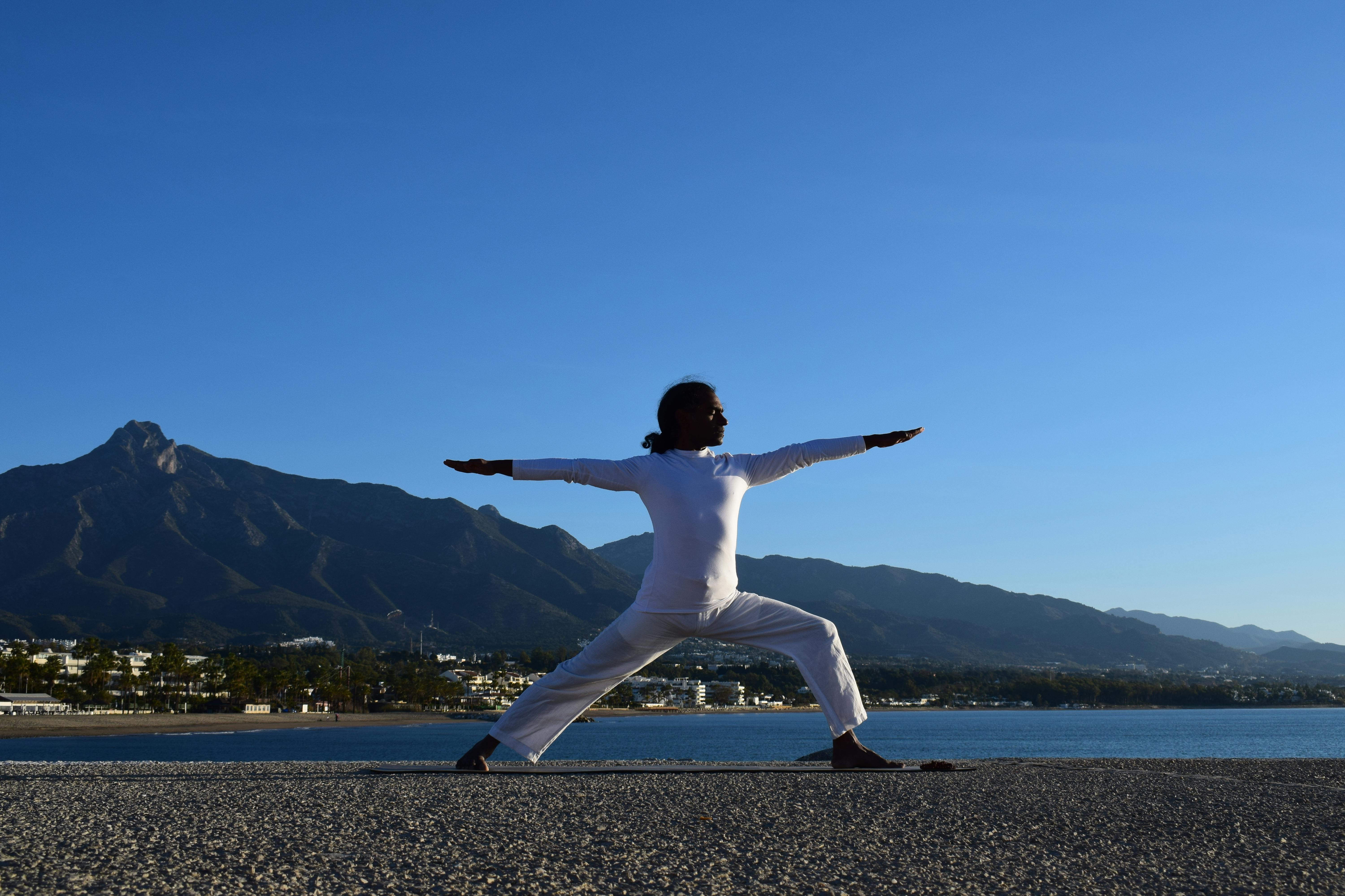 Man in White Clothes Meditating · Free Stock Photo