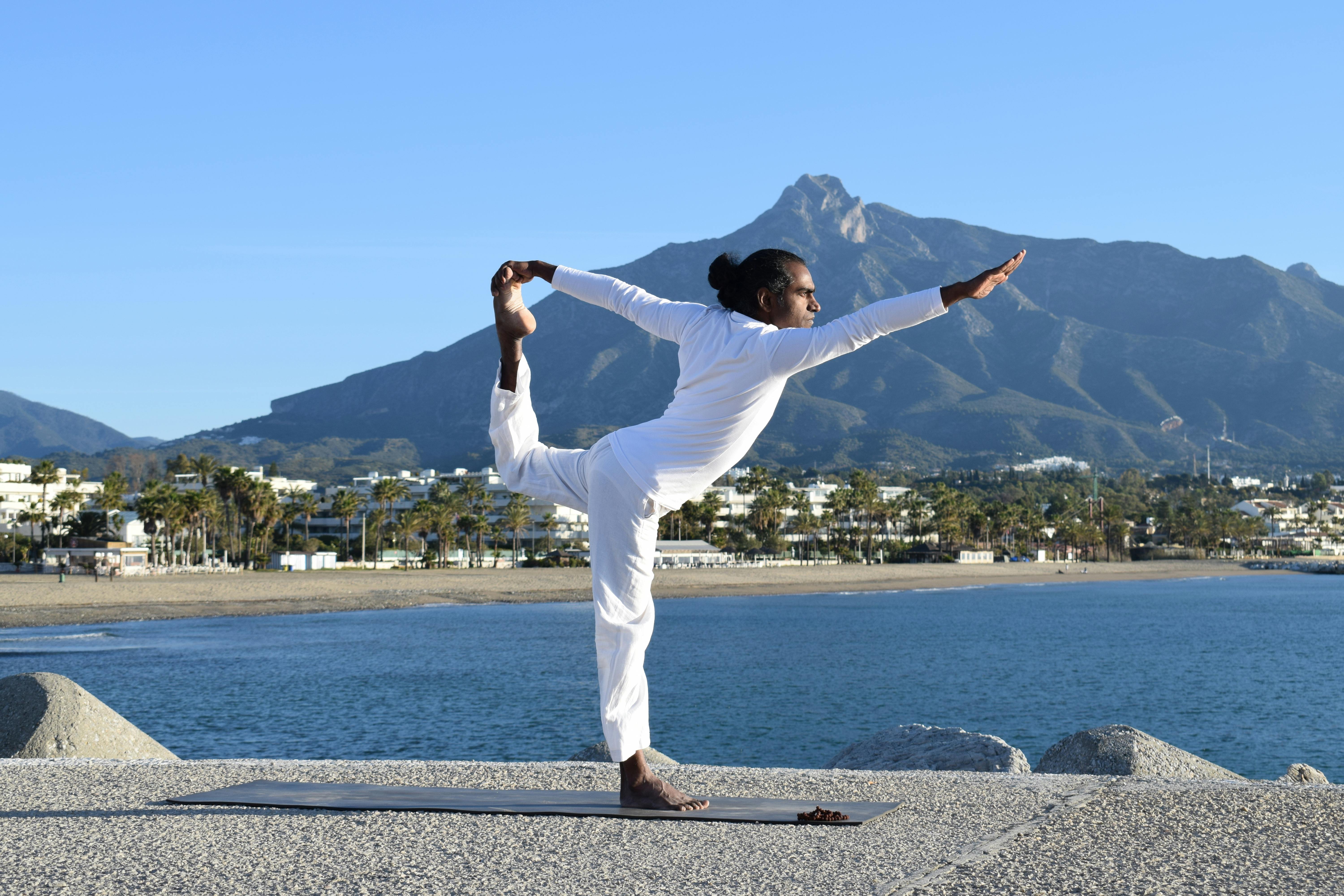 Man Wearing White Clothes Balancing His Body · Free Stock Photo
