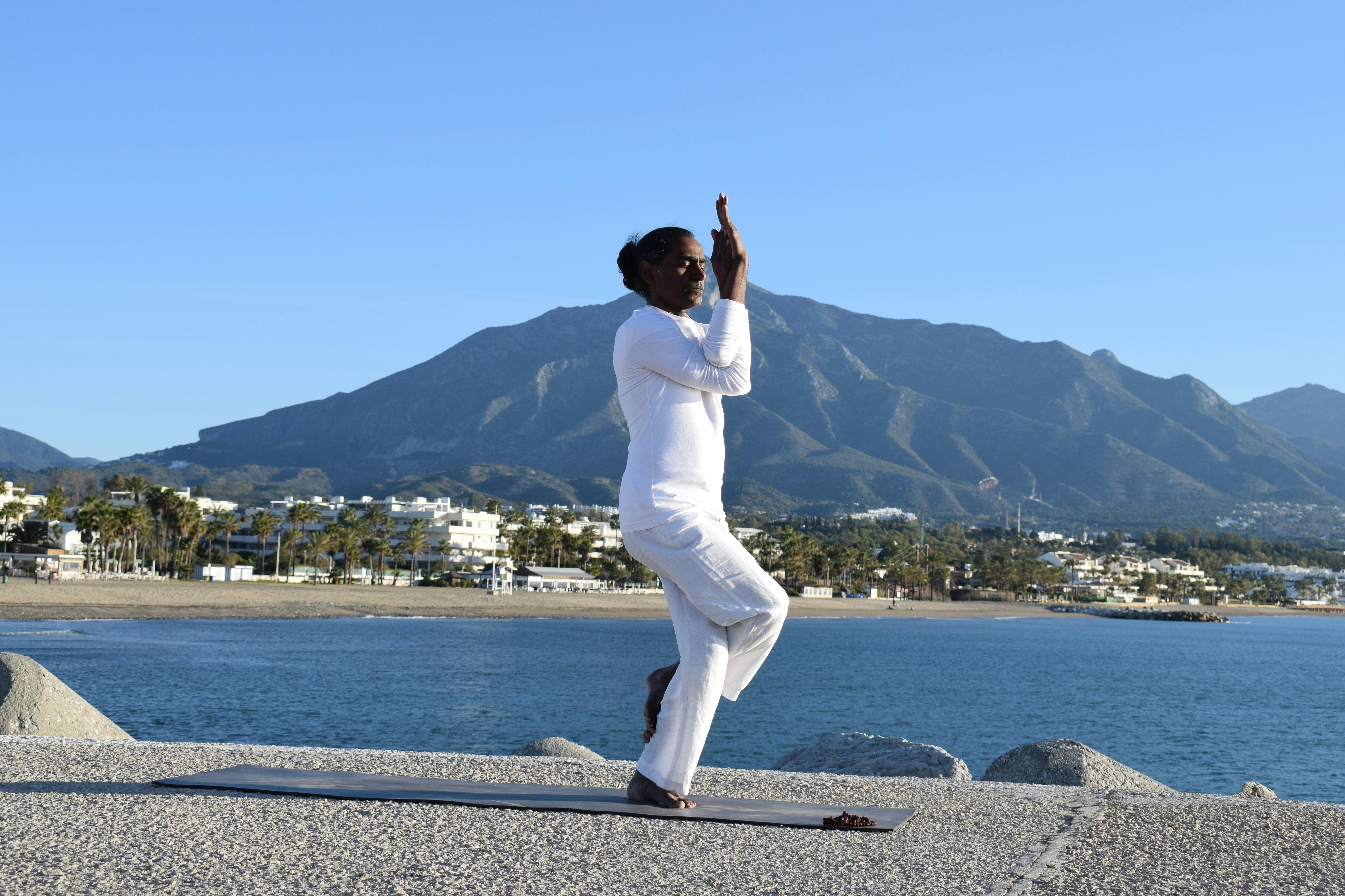 Man in White Clothes Meditating · Free Stock Photo