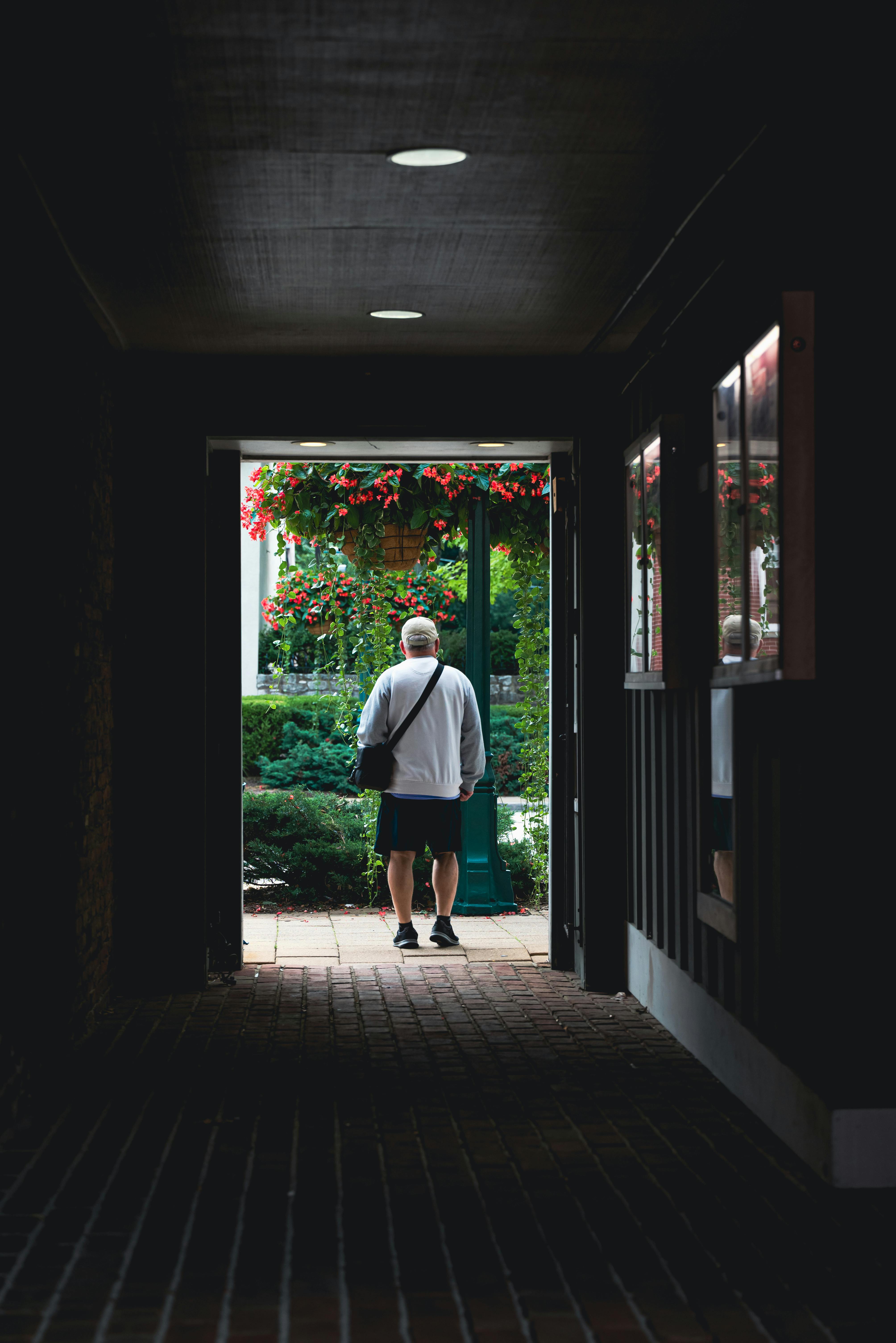 Man Walking Hallway in Old Building · Free Stock Photo
