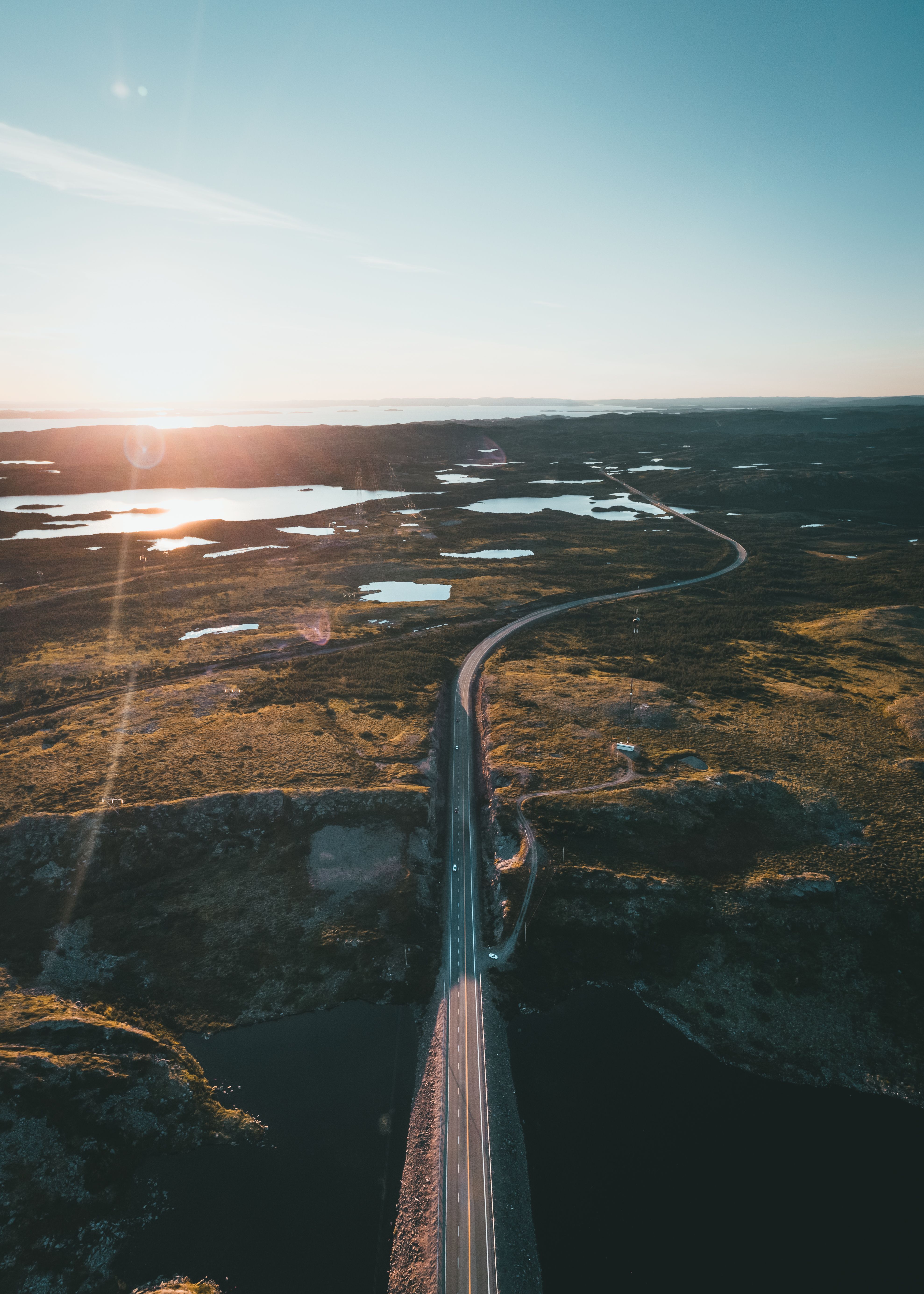 Sunrise over Plains with Lakes and Road · Free Stock Photo