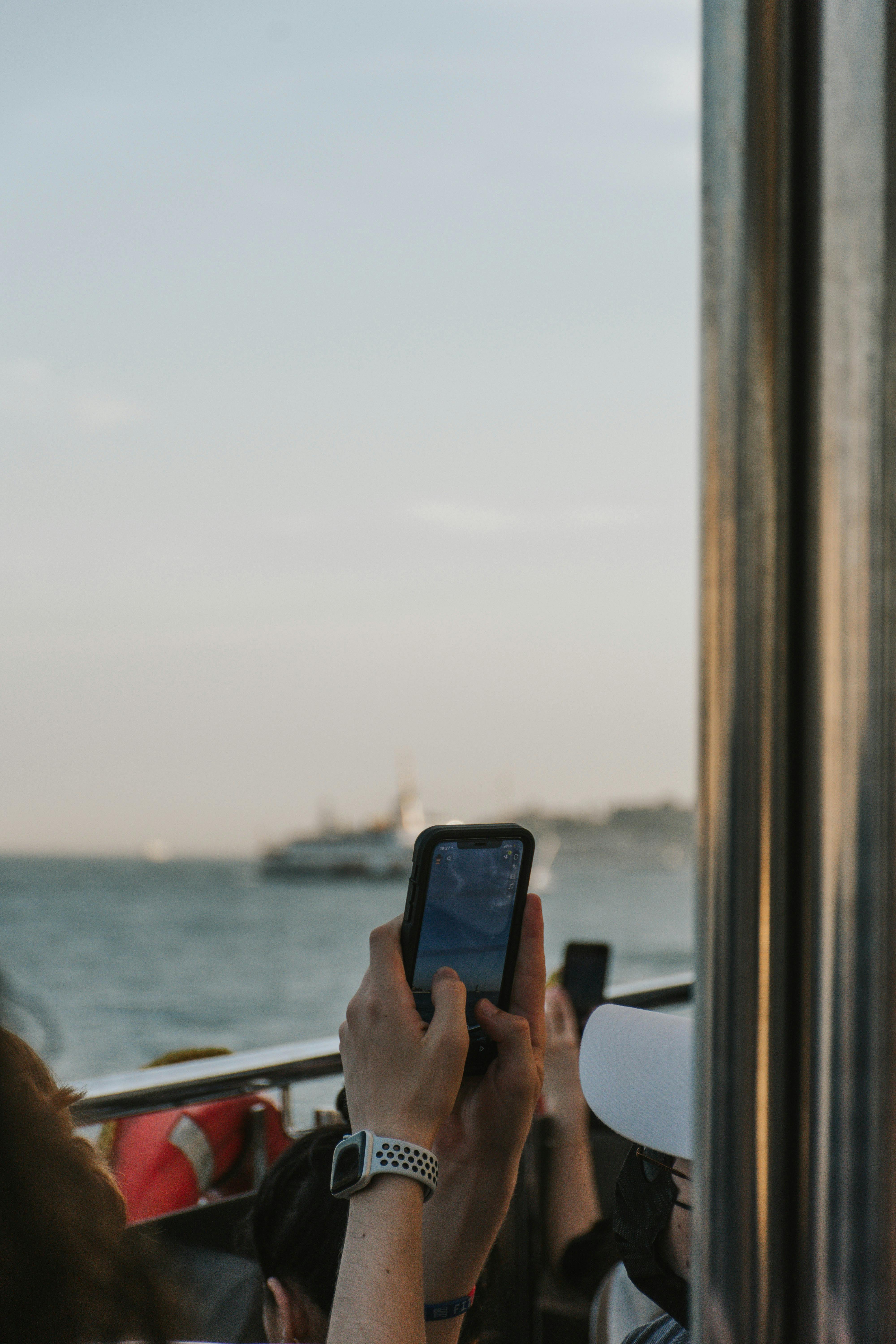 Man on a Boat Using Smartphone · Free Stock Photo