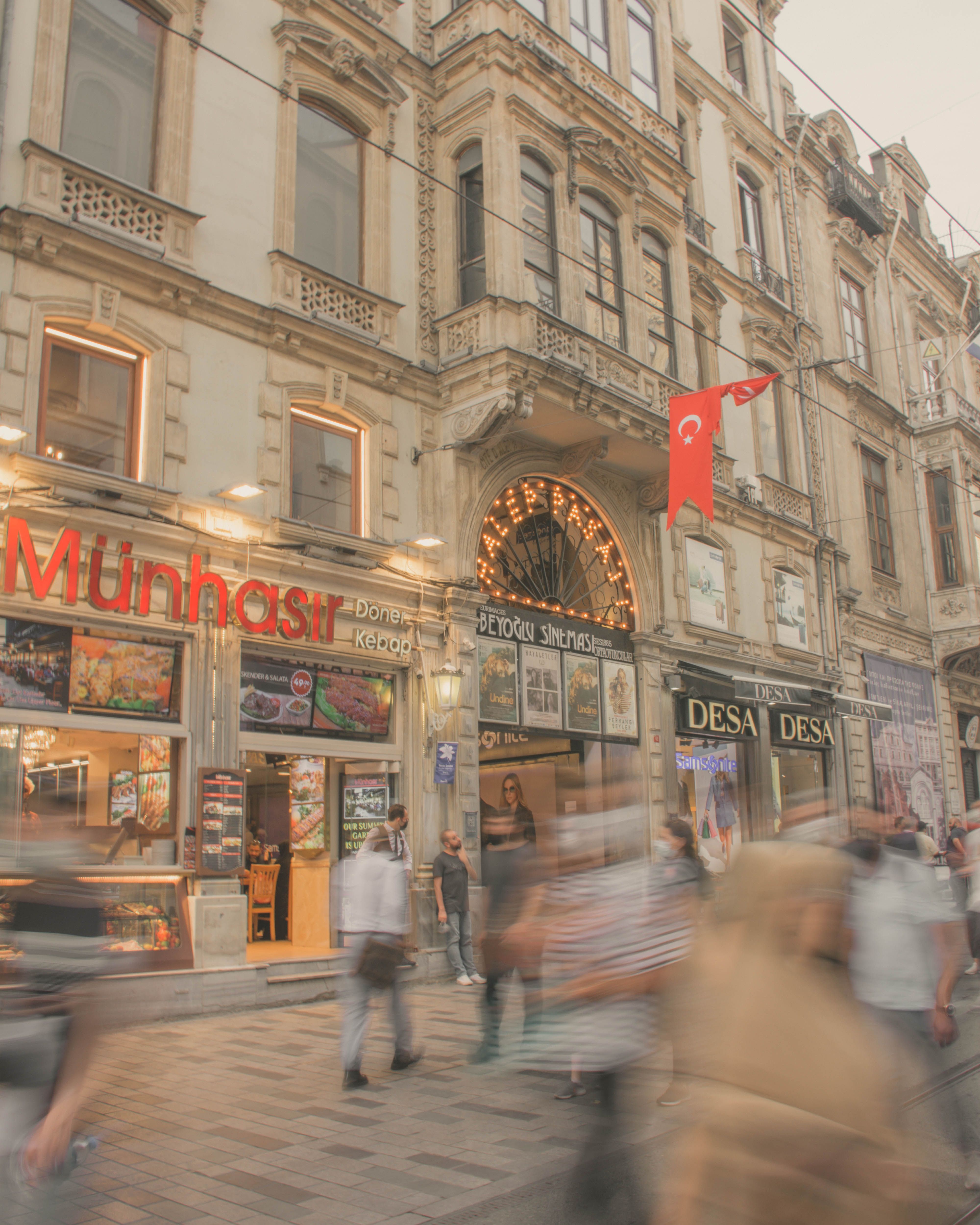 People Walking on Street Between Buildings · Free Stock Photo