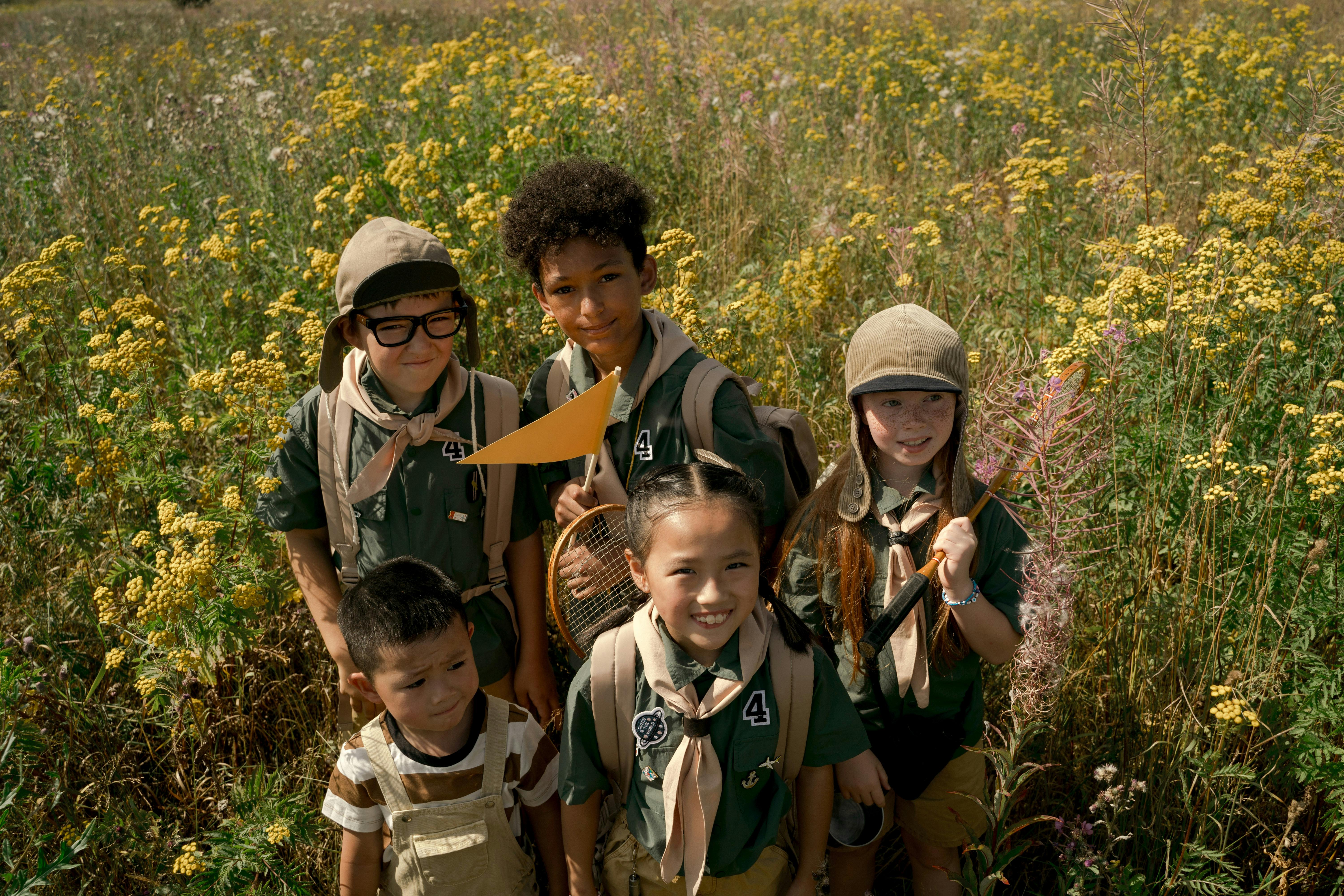 Group of Scouts Standing on a Meadow and Smiling · Free Stock Photo