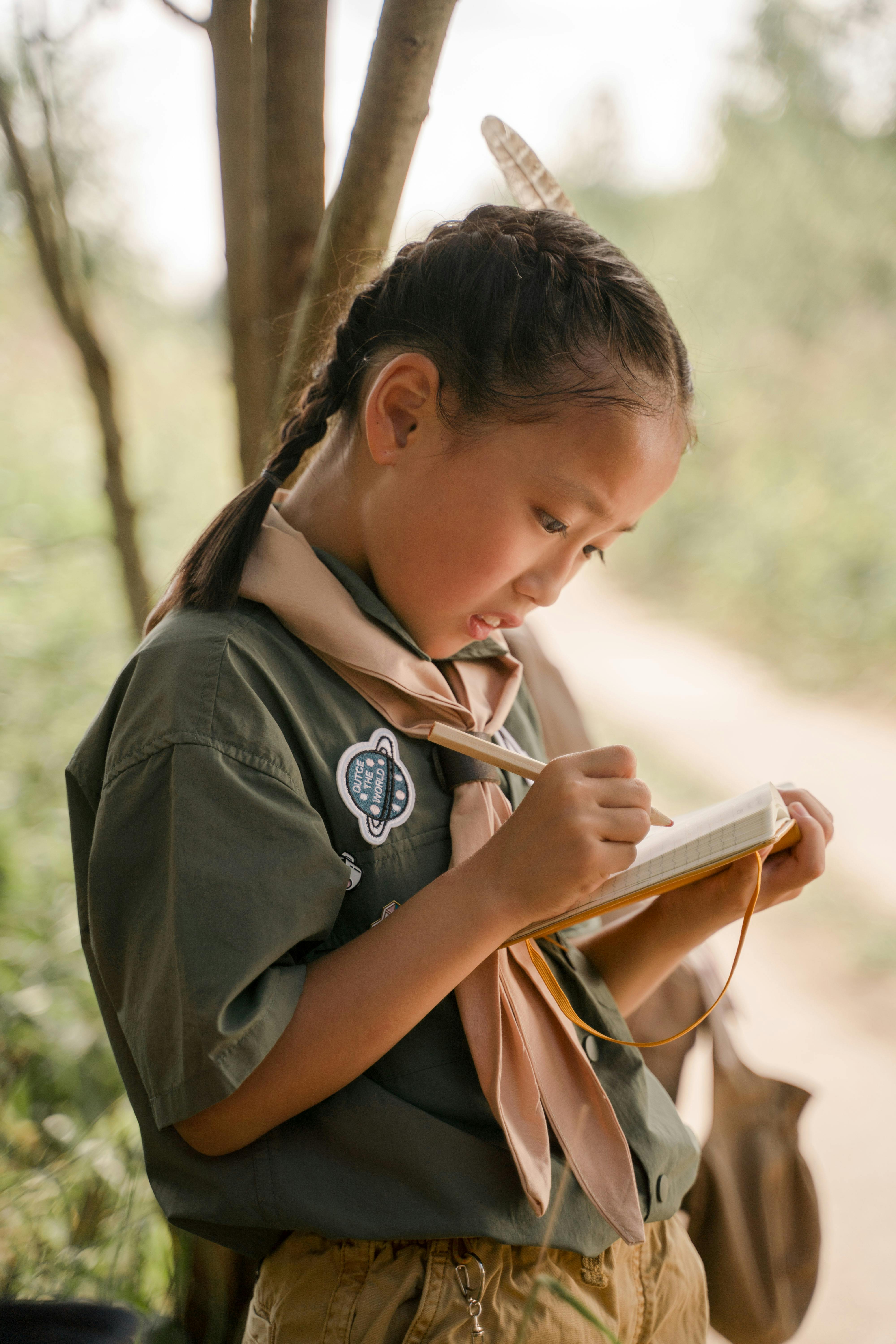 Two Girls Scout Looking the Notebook Together · Free Stock Photo