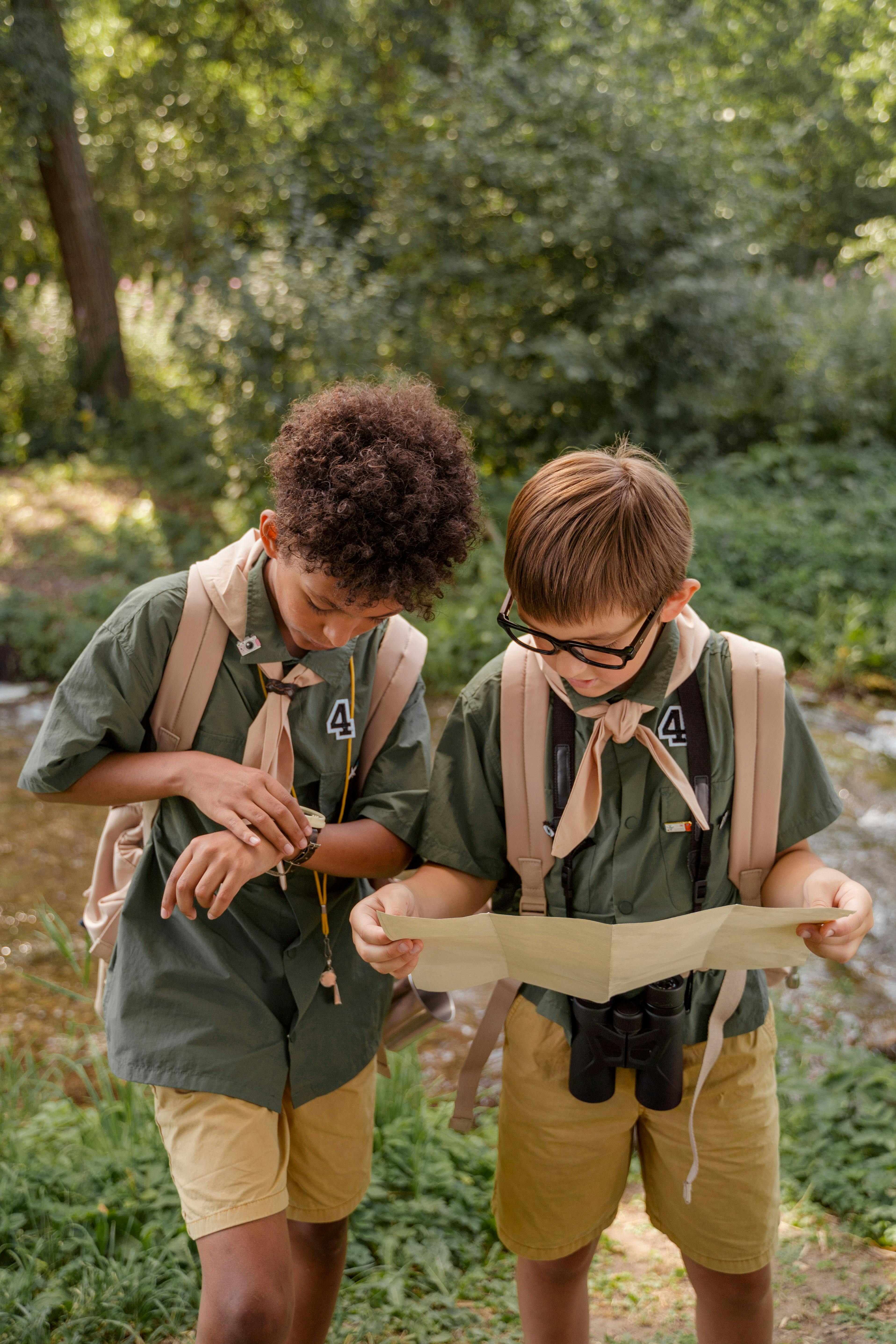 Scouts Looking at Map in Forest · Free Stock Photo